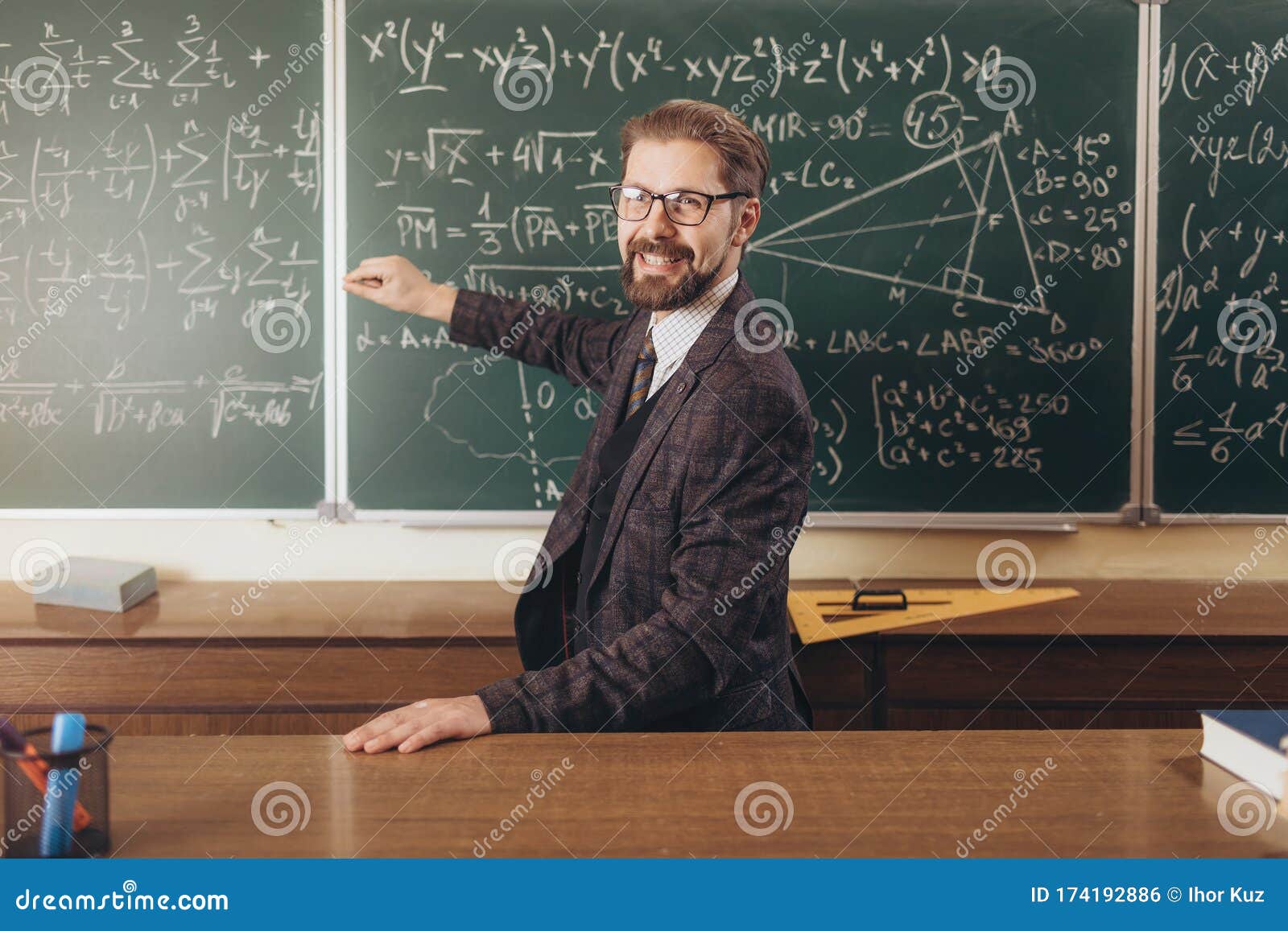 Bearded Professor At School Lesson At Desks In Classroom. Back To ...