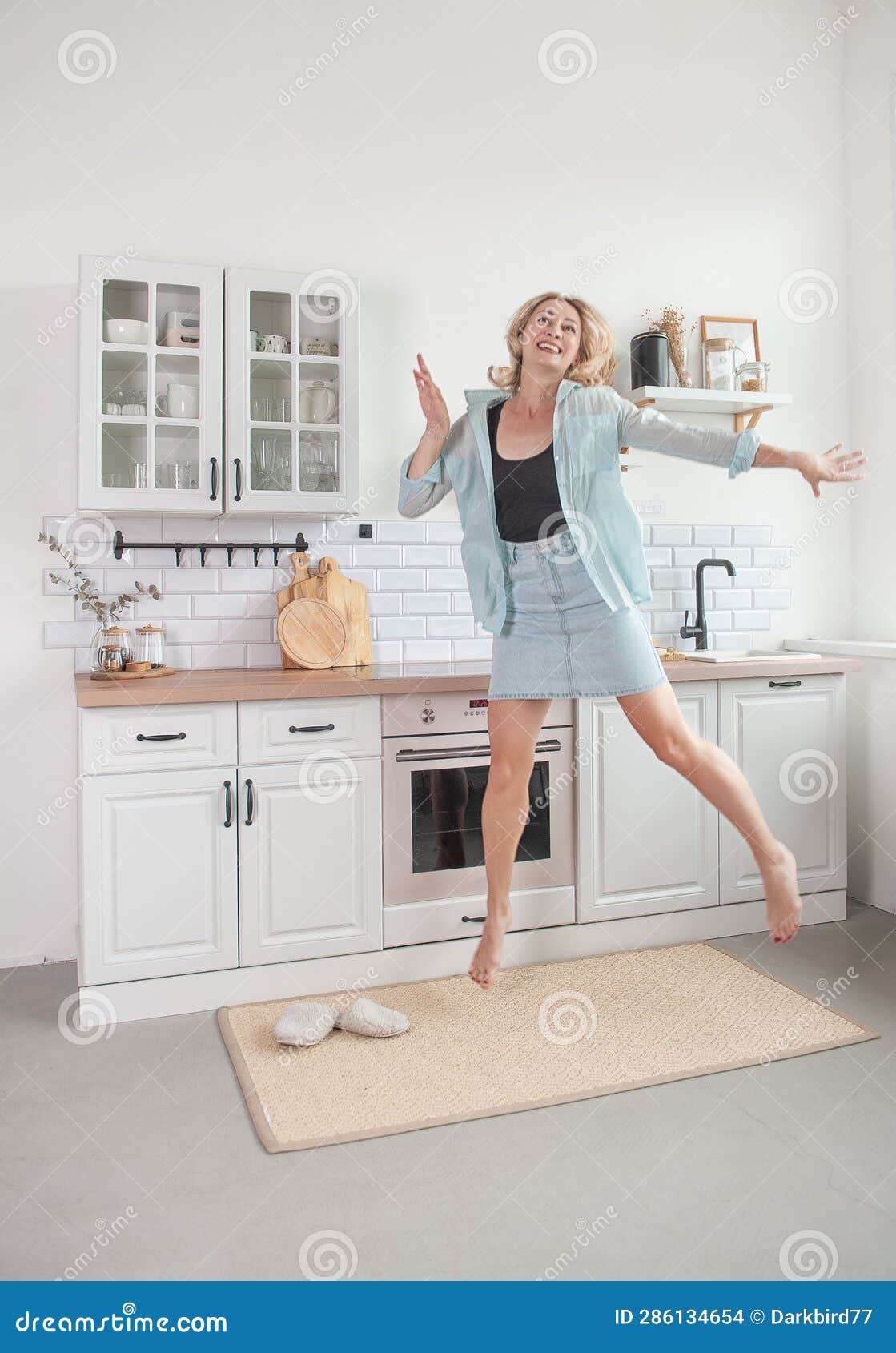 Cheerful Woman Jumping and Dancing in the Kitchen Stock Photo - Image ...