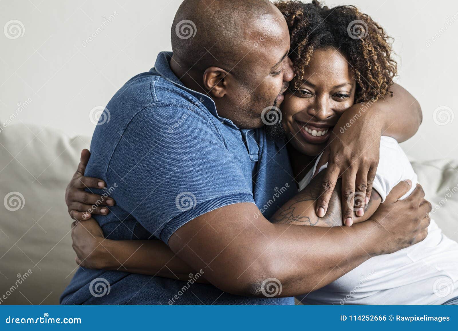 A Cheerful Black Couple Hugging Each Other Stock Photo - Image of care ...