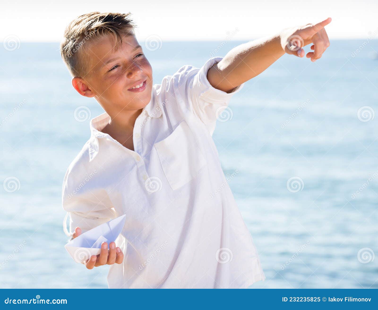 Boy pointing beach stock image. Image of elementary - 232235825