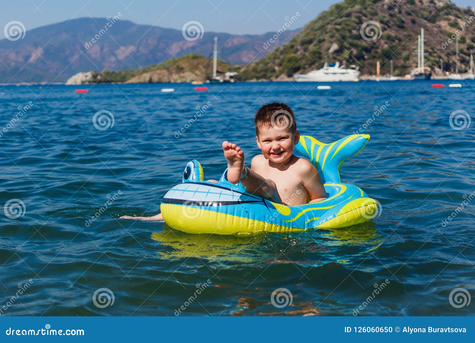 Cheerful Boy Sitting in an Inflatable Boat on the Sea Stock Photo ... Cheerful Boy Sitting in an Inflatable Boat on the Sea Stock Photo ...