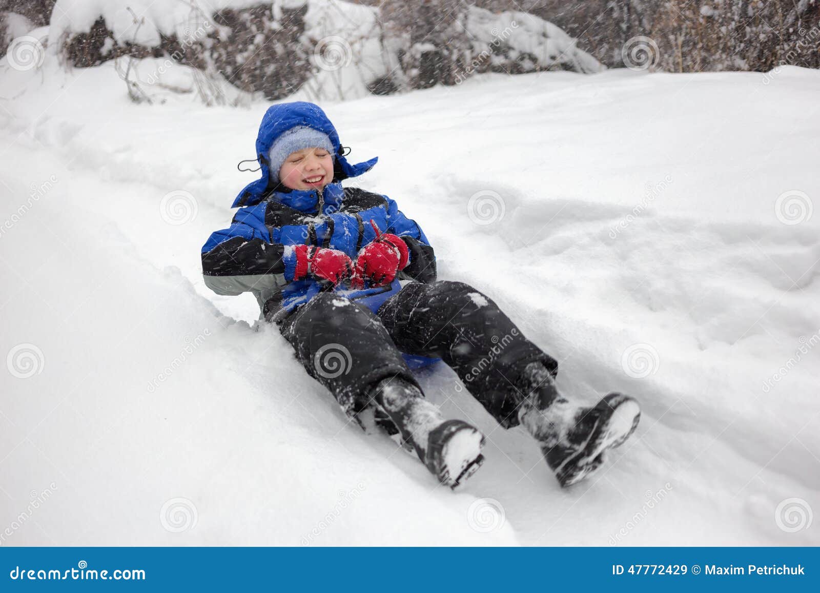 Cheerful boy sledding stock image. Image of child, happy - 47772429