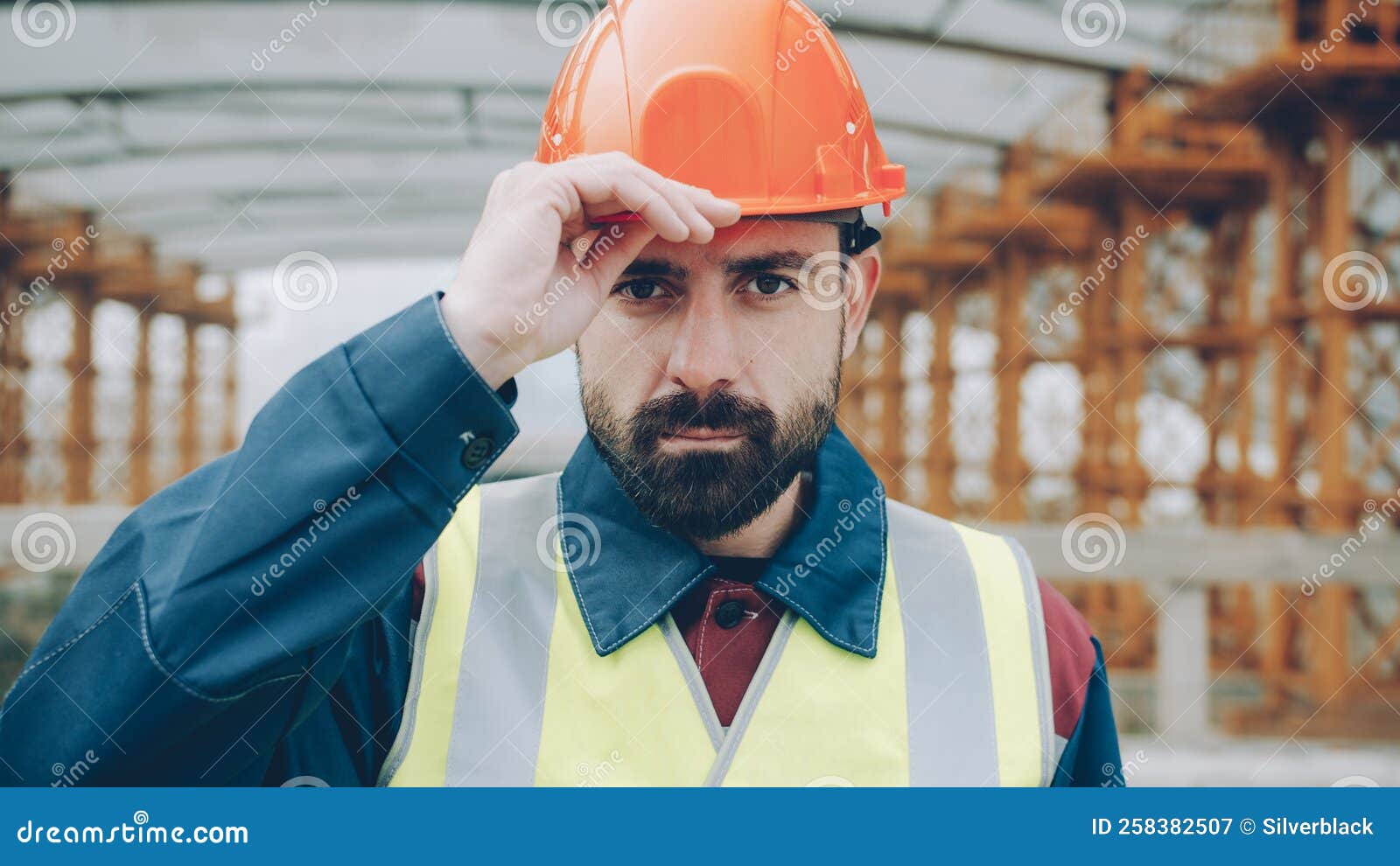 Cheerful Builder Putting on Safety Helmet and Smiling Standing in ...
