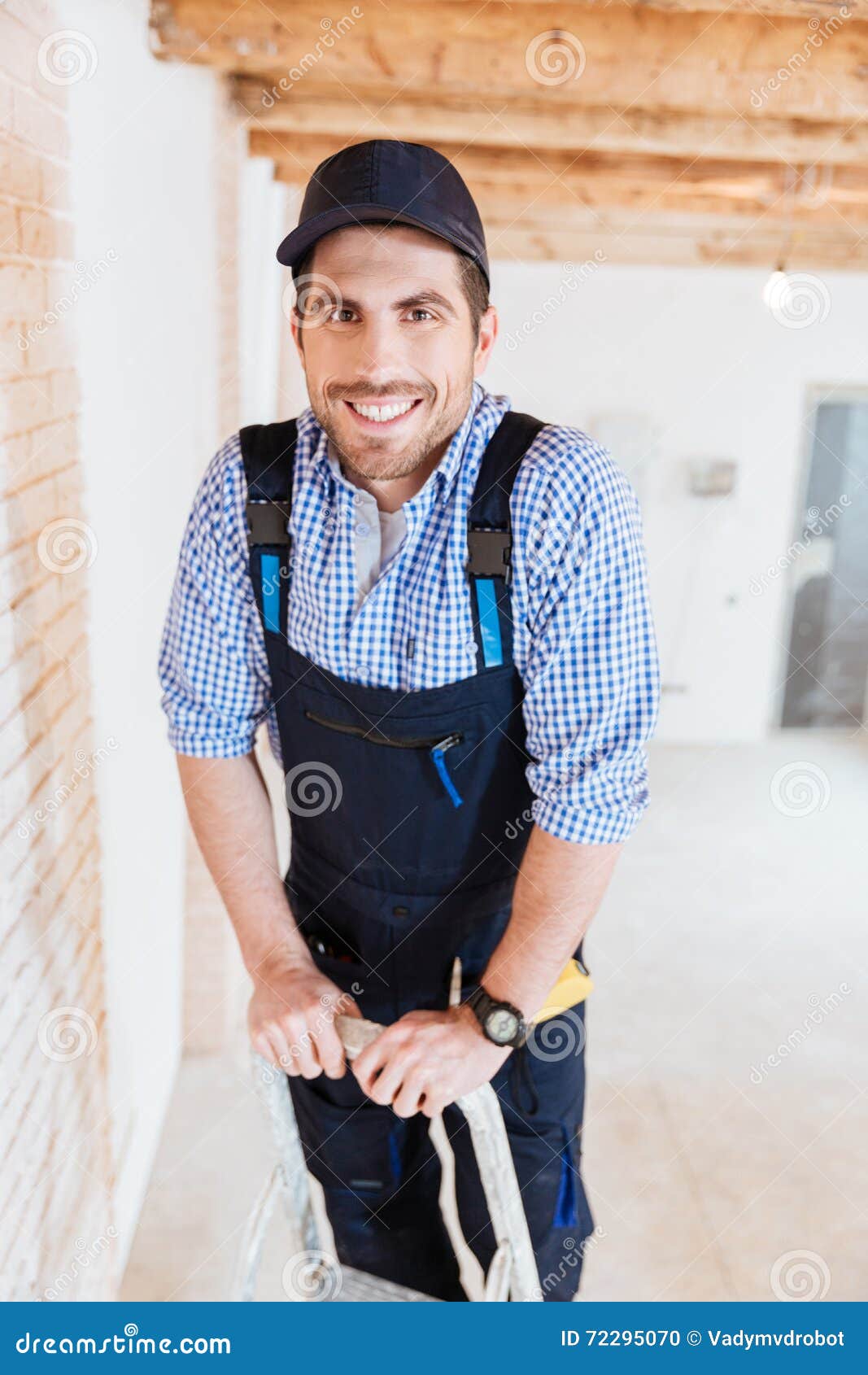 Cheerful Builder Smiling and Standing on the Ladder Stock Photo - Image ...