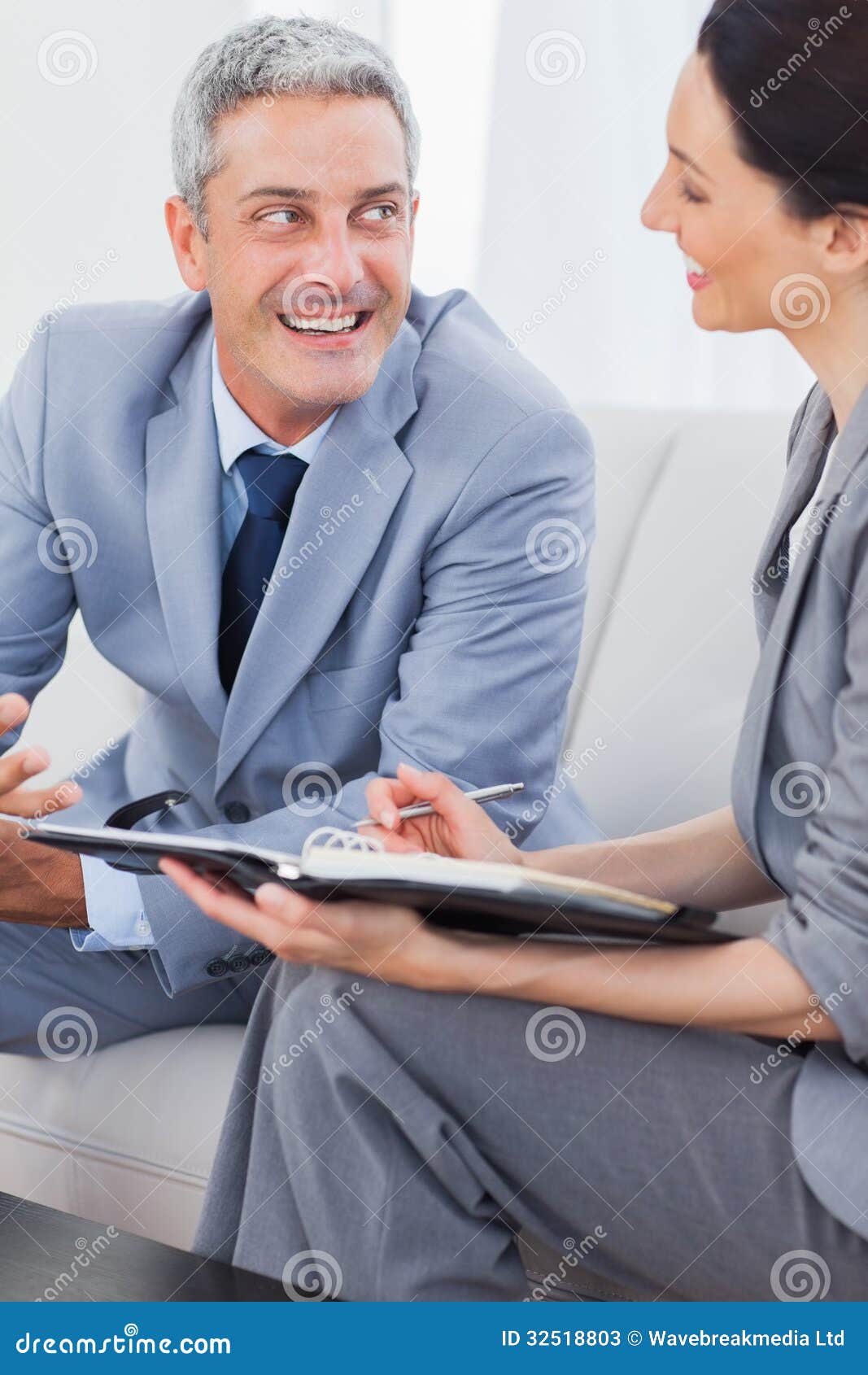 Cheerful Business People Working and Talking Together on Sofa Stock ...