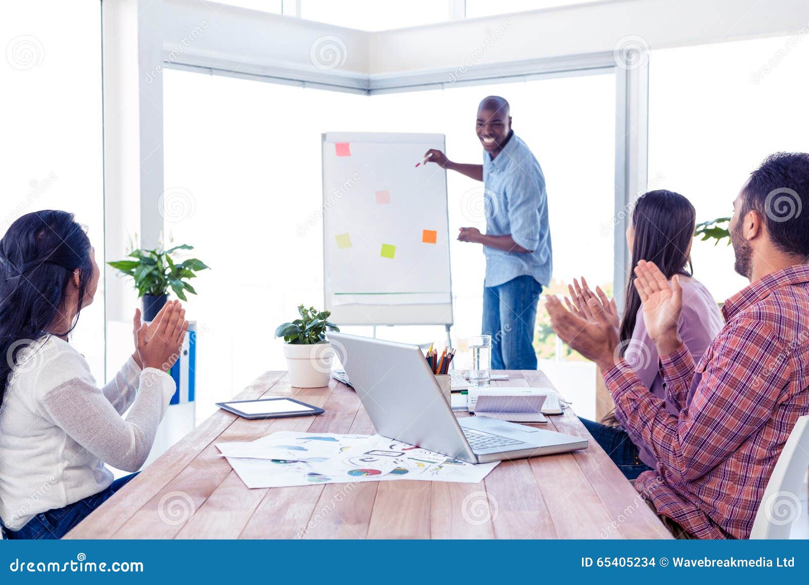 Cheerful Businessman Giving Presentation while Team Applauding in ...