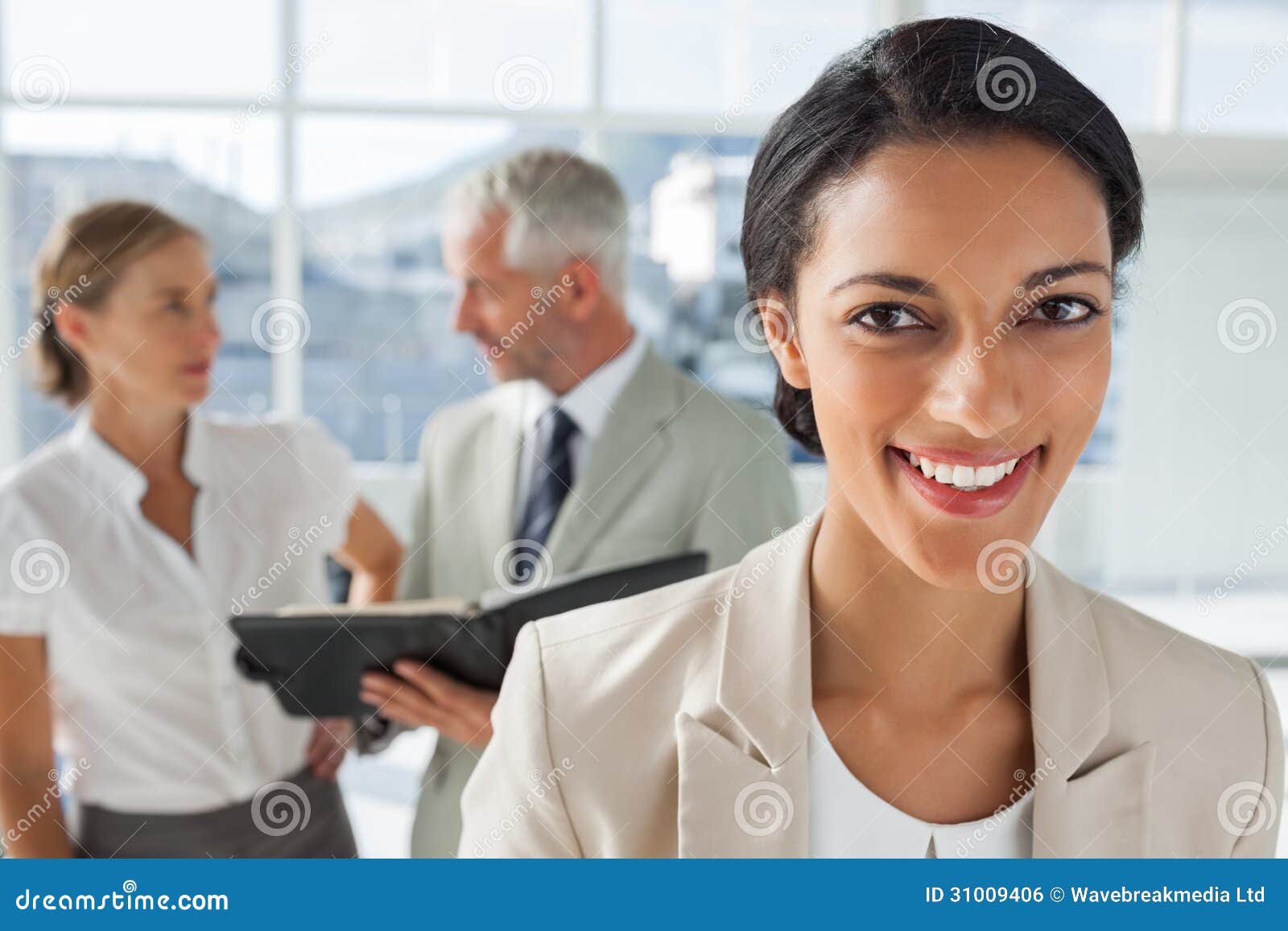 Cheerful Businesswoman in Front of Colleagues Working Behind Stock ...