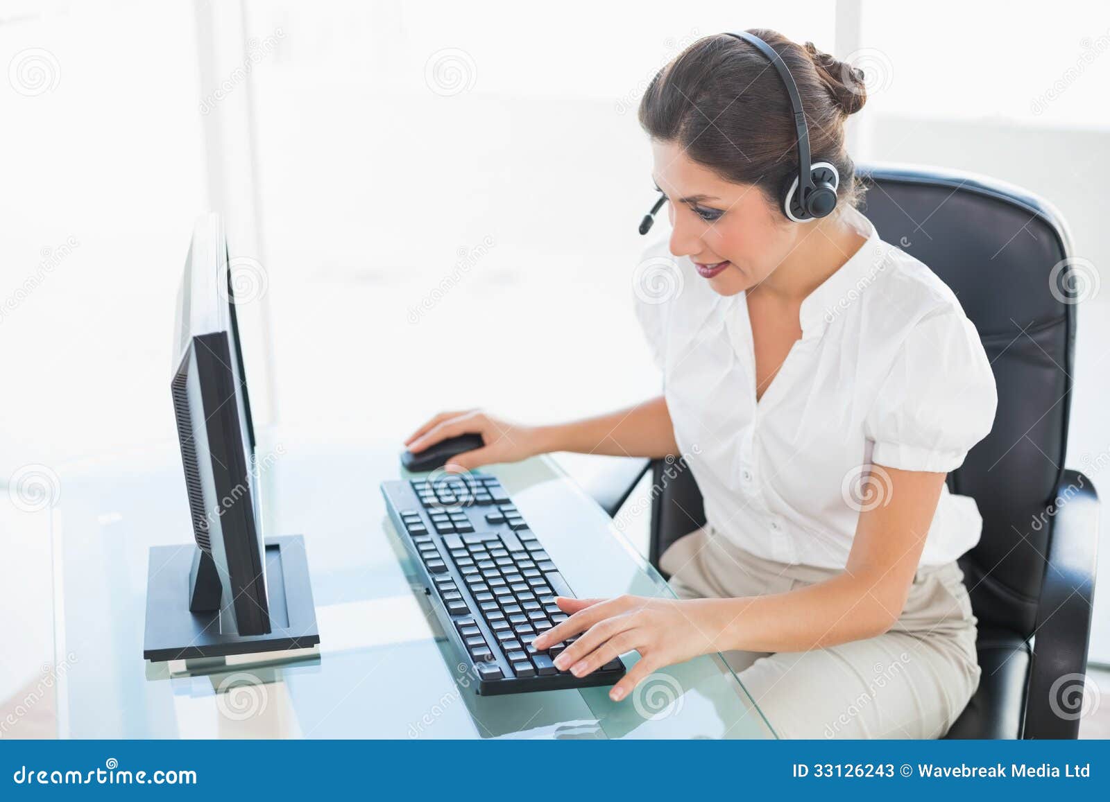 Cheerful Call Centre Agent Working on Computer while on a Call Stock ...