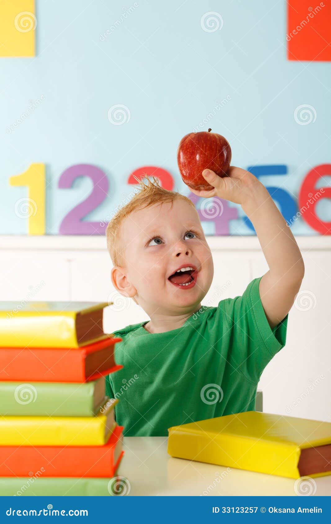 Cheerful child with apple stock image. Image of book - 33123257