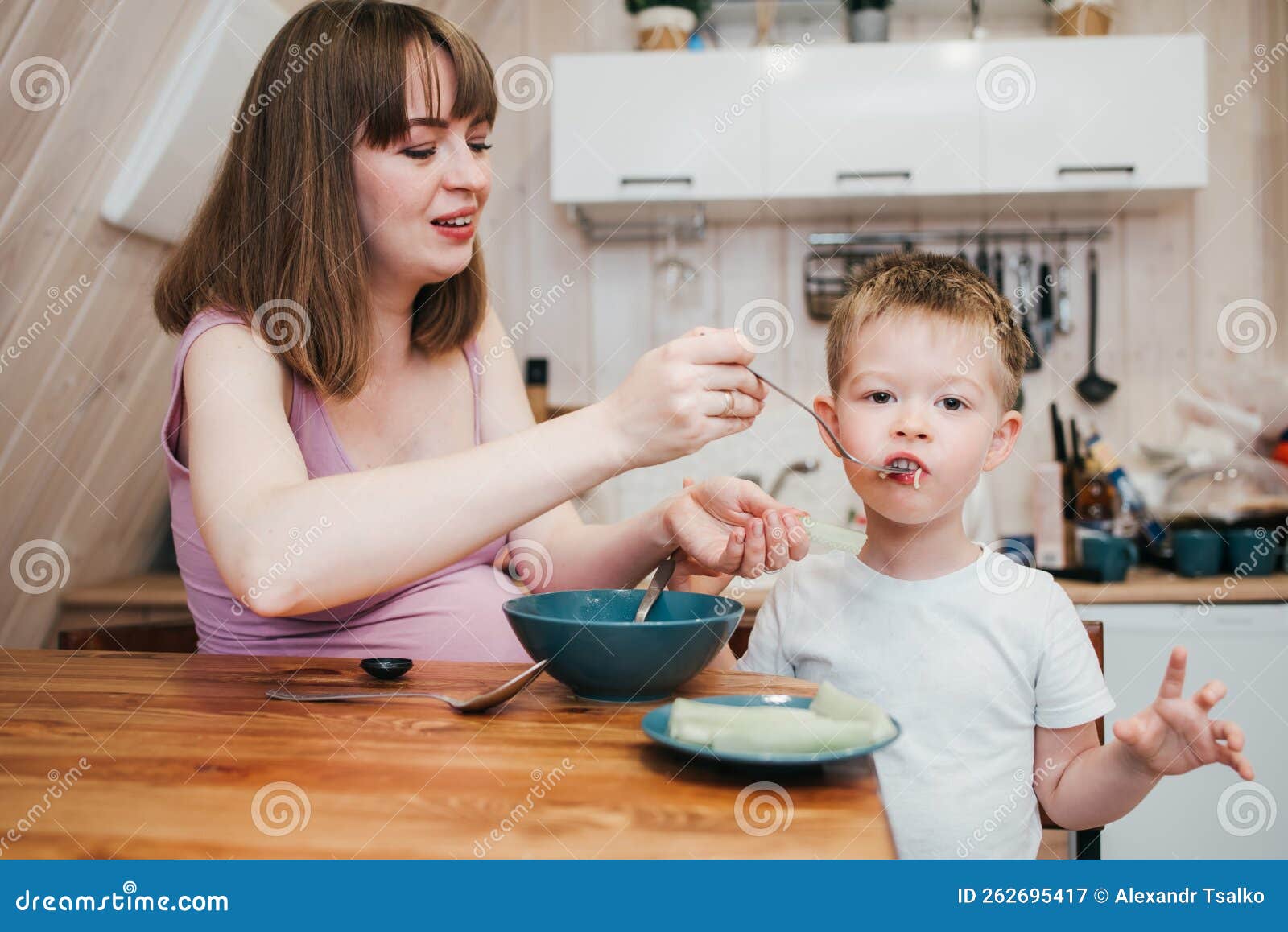 Cheerful Child Eating Pasta in the Kitchen with Mom Stock Image - Image ...