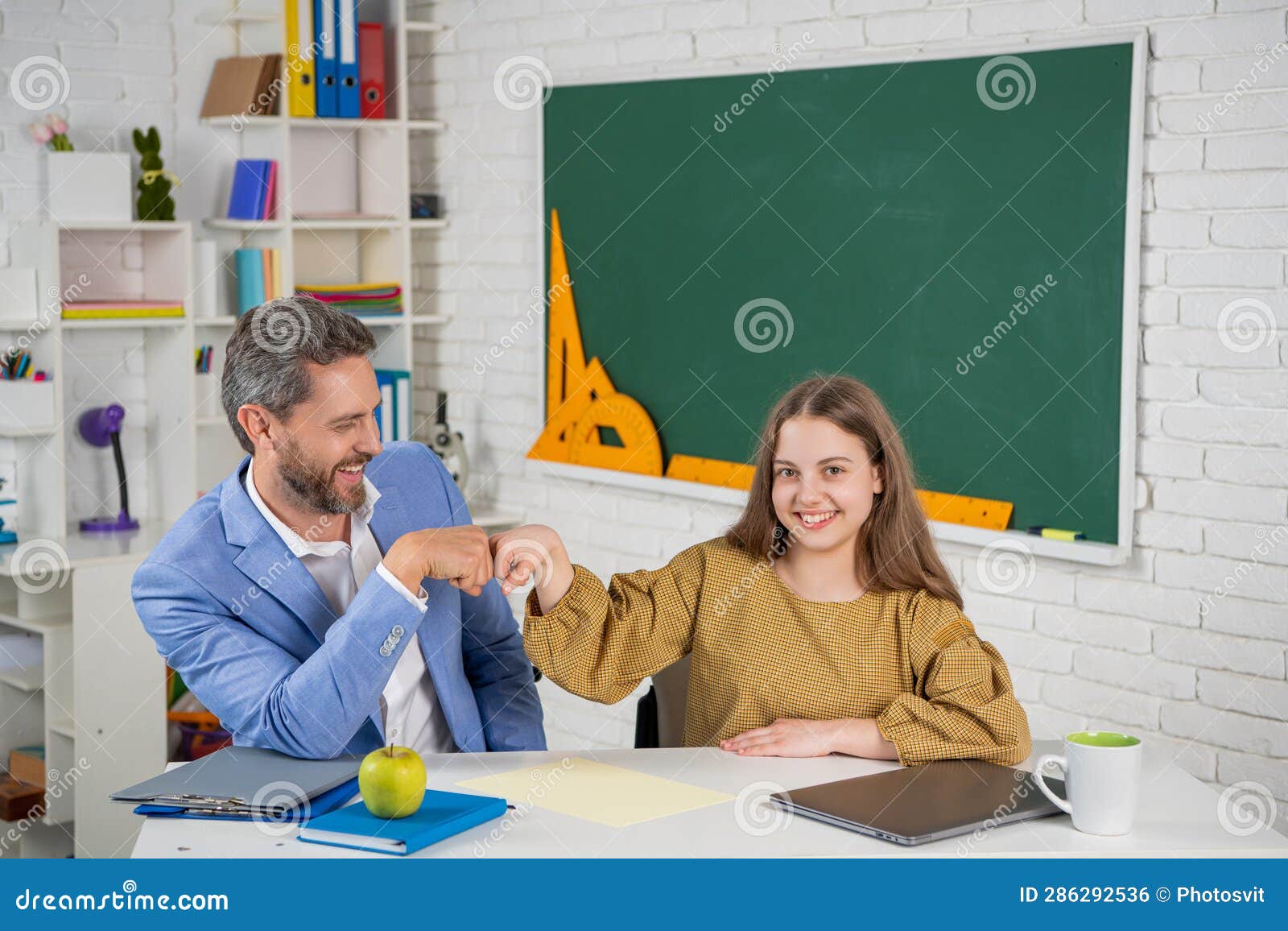 Cheerful Child Study in Classroom with Tutor. Fist To Fist Stock Photo ...
