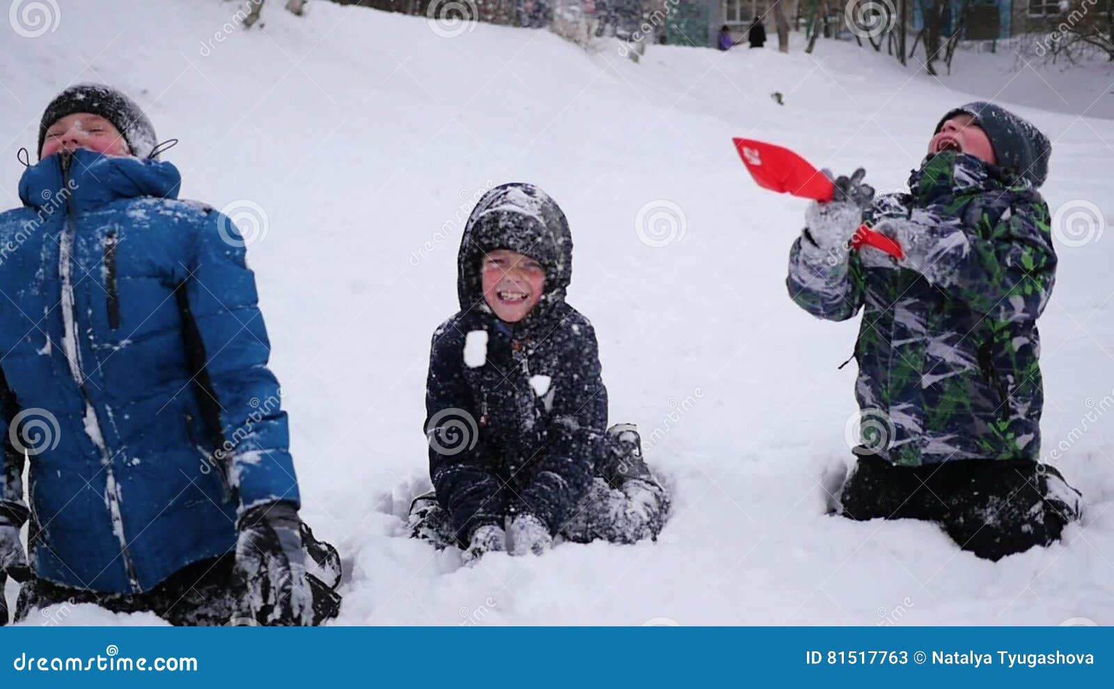 Cheerful Children Playing in the Snow Throwing Snow Up in Park Stock ...