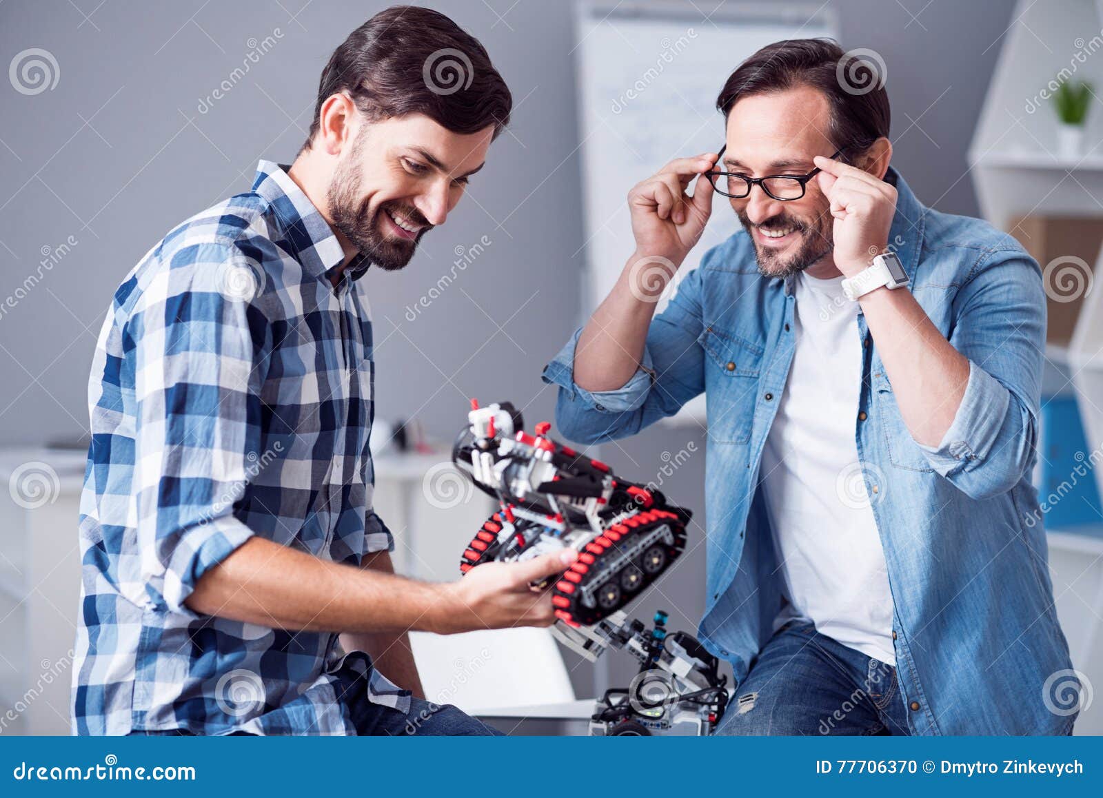 Cheerful Colleagues Testing Robot Stock Photo - Image of indoor ...