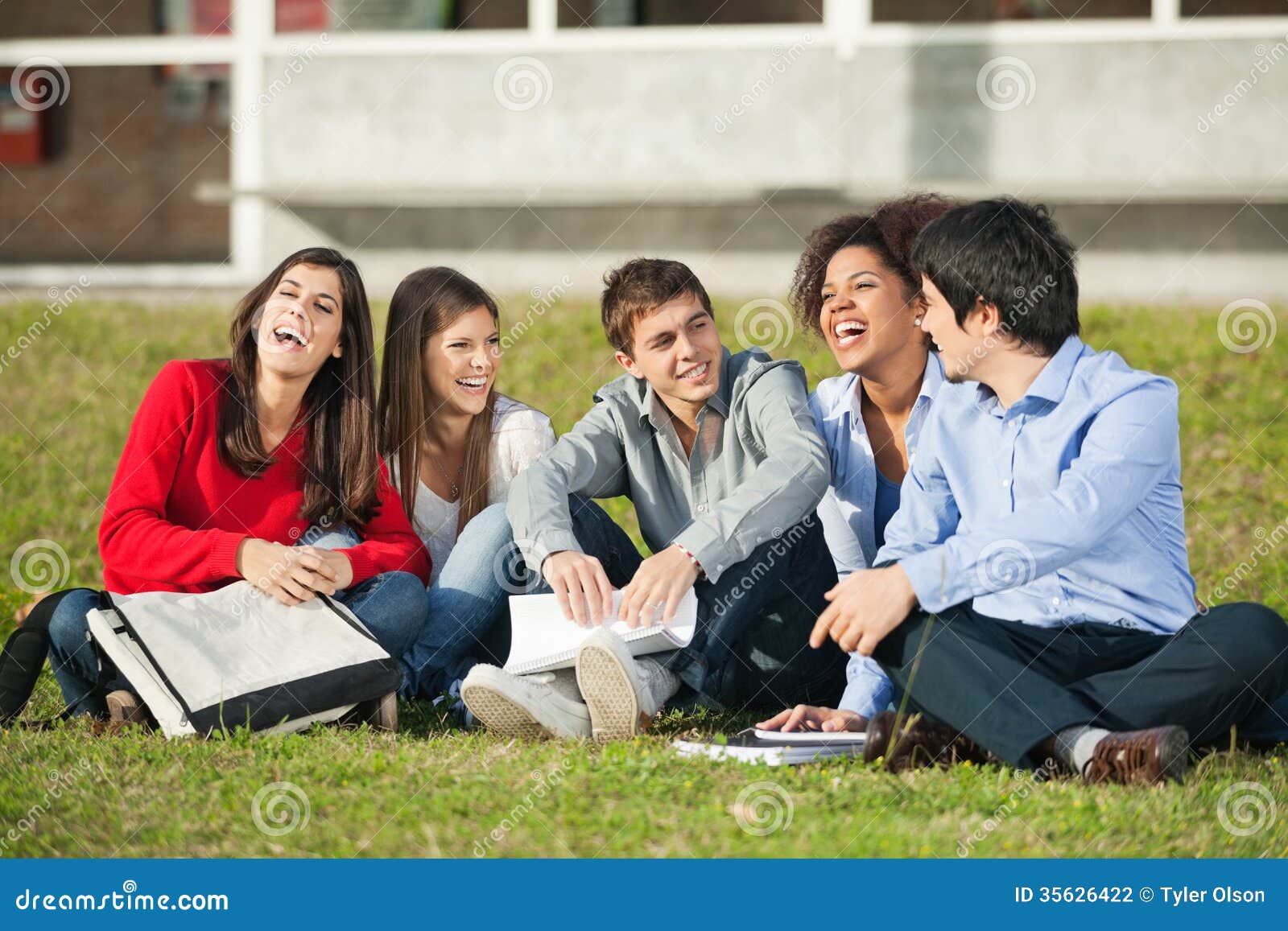 Cheerful College Students Sitting on Grass at Stock Photo - Image of ...