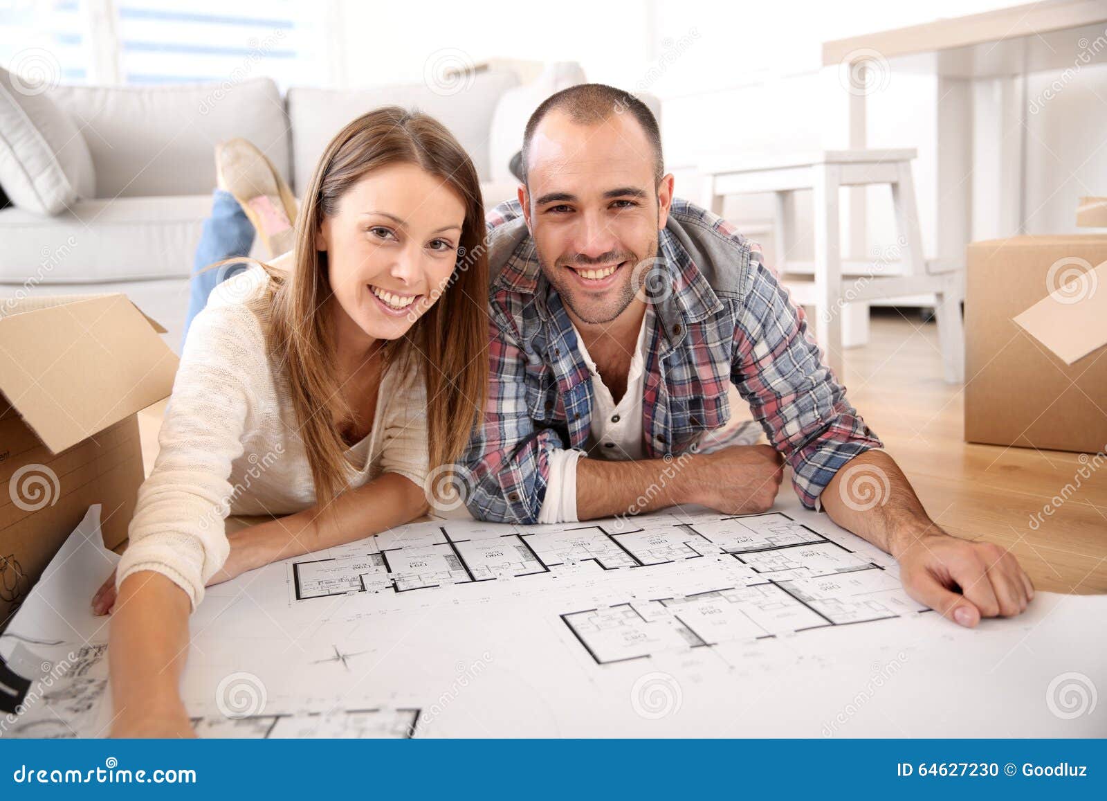 Cheerful Couple Looking at Construction Plan Stock Photo - Image of ...