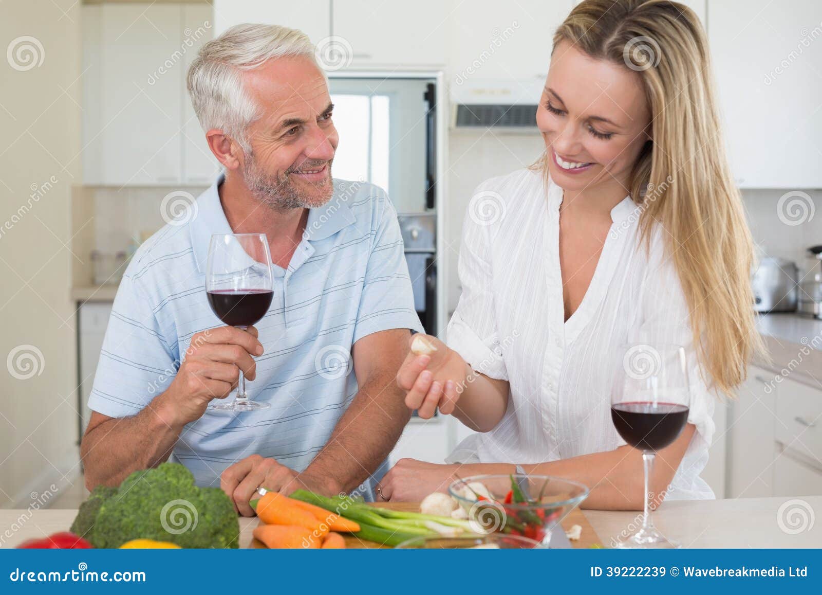 Cheerful Couple Making Dinner Together and Drinking Red Wine Stock ...