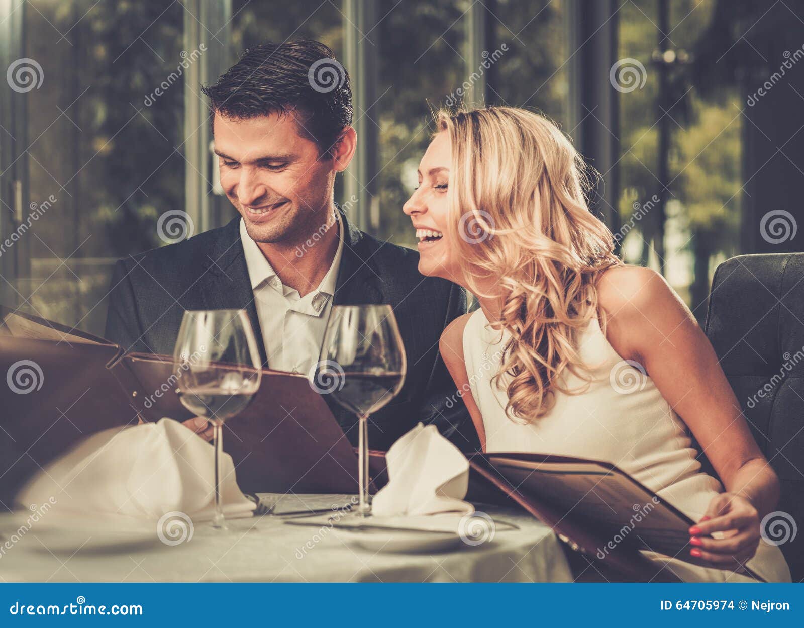 Cheerful couple with menu. stock photo. Image of anniversary - 64705974