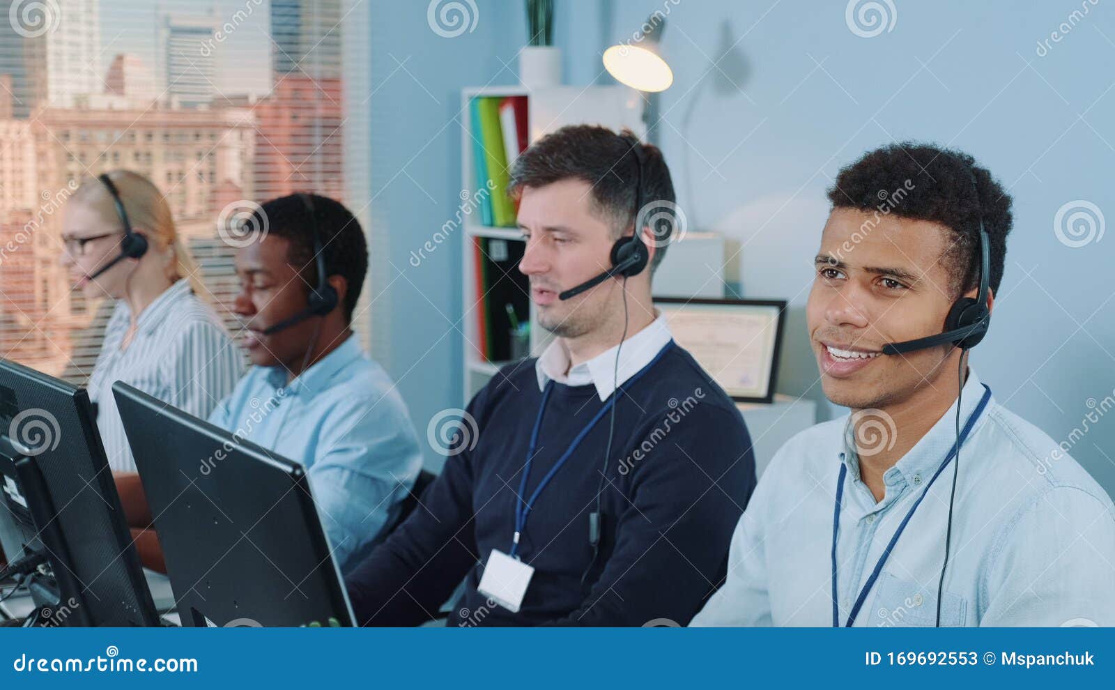 Cheerful Customer Support Agent of Mixed Ethnicity Talking on Phone ...