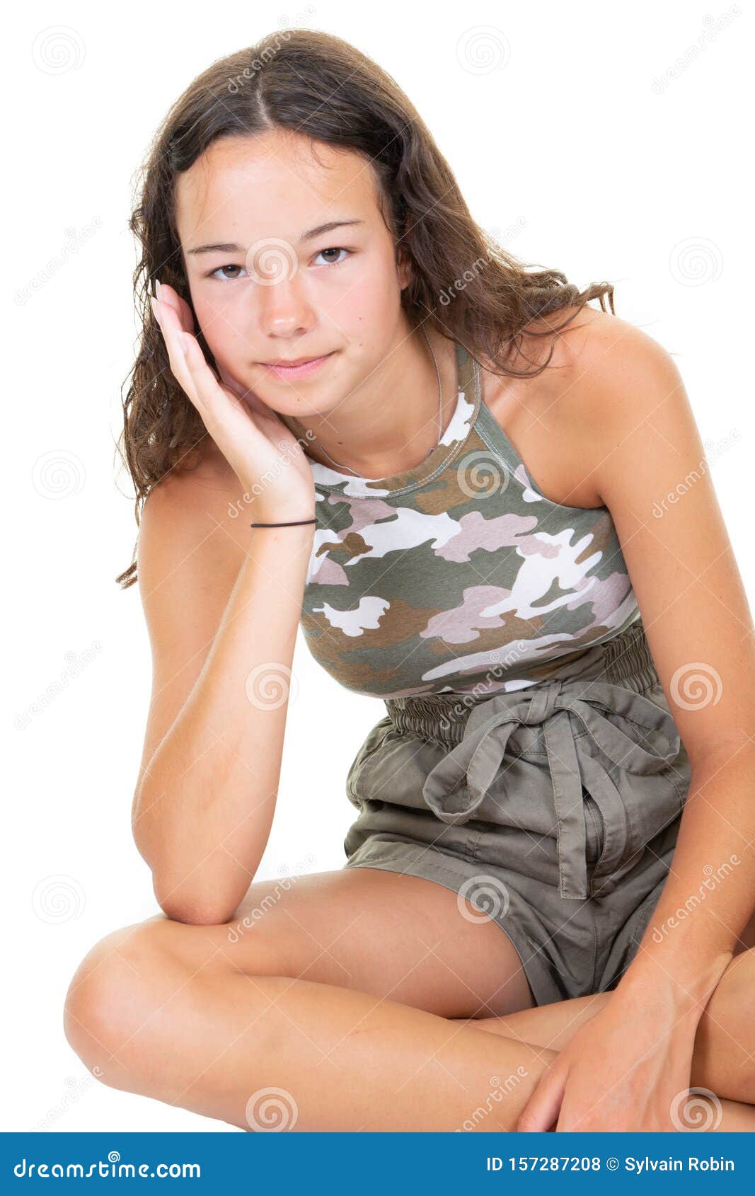 Cheerful Cute Teen Girl Sit On Floor Isolated On A White Background