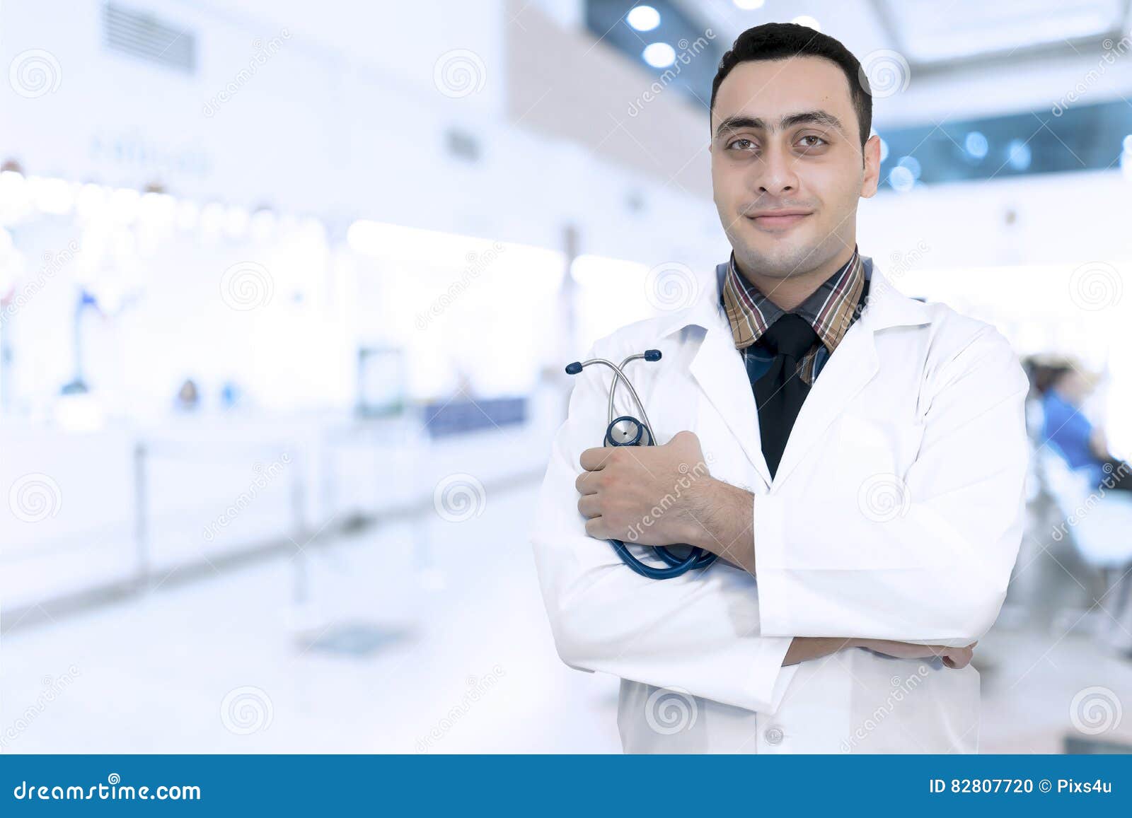 Cheerful Doctor Standing in a Hospital Stock Photo - Image of adult ...