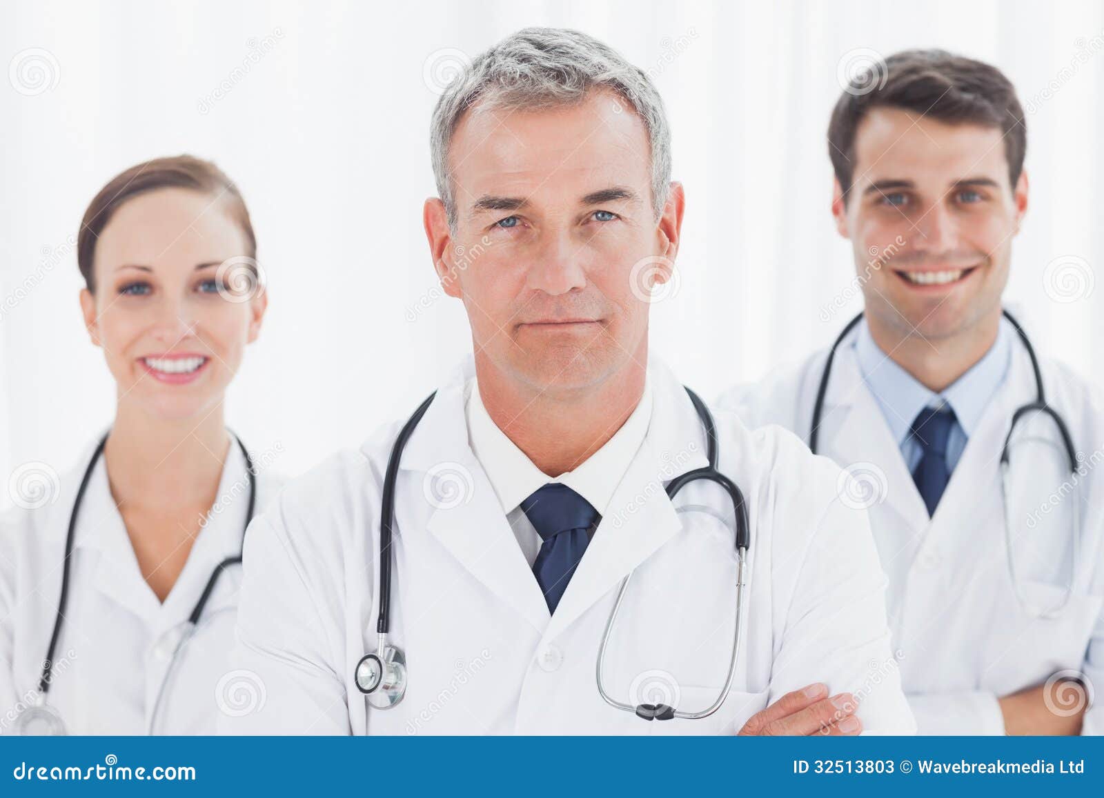 Cheerful Doctors Posing Together Crossing Arms Stock Image - Image of ...