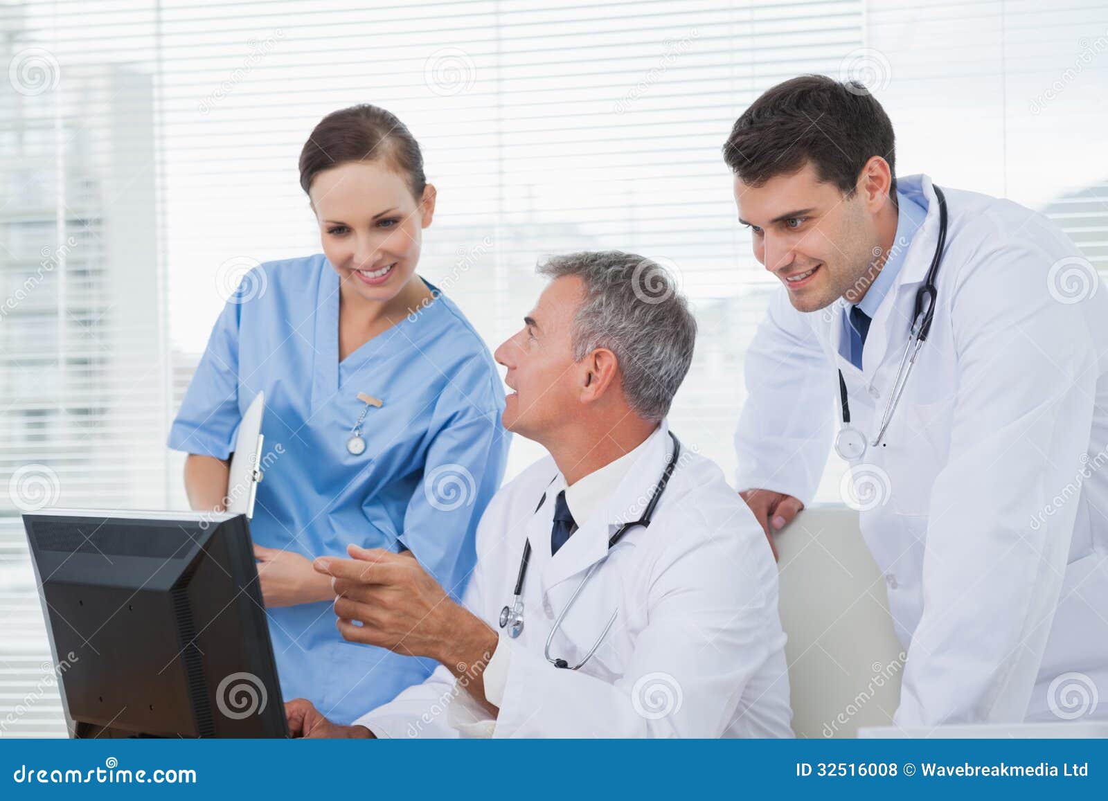 Cheerful Doctors and Surgeon Working Together on Computer Stock Photo ...