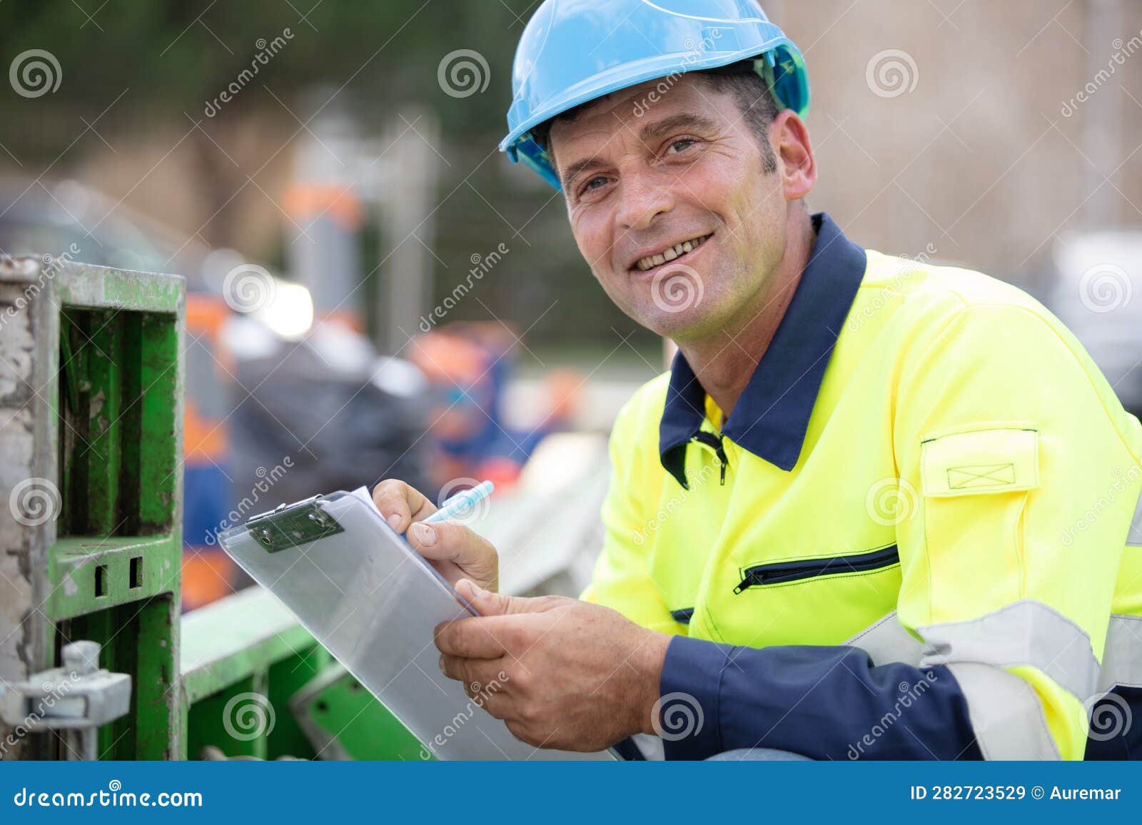 Cheerful Engineer with Clipboard Wearing Reflective Vest on ...