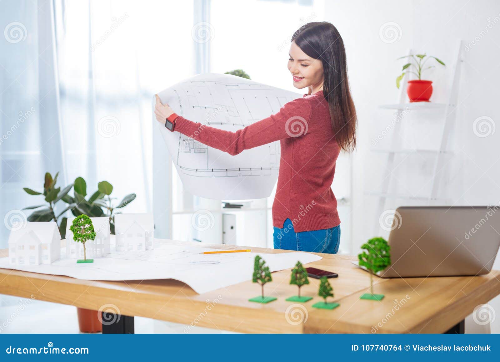 Cheerful Engineer Smiling while Comparing Two Detailed Schemes Stock ...