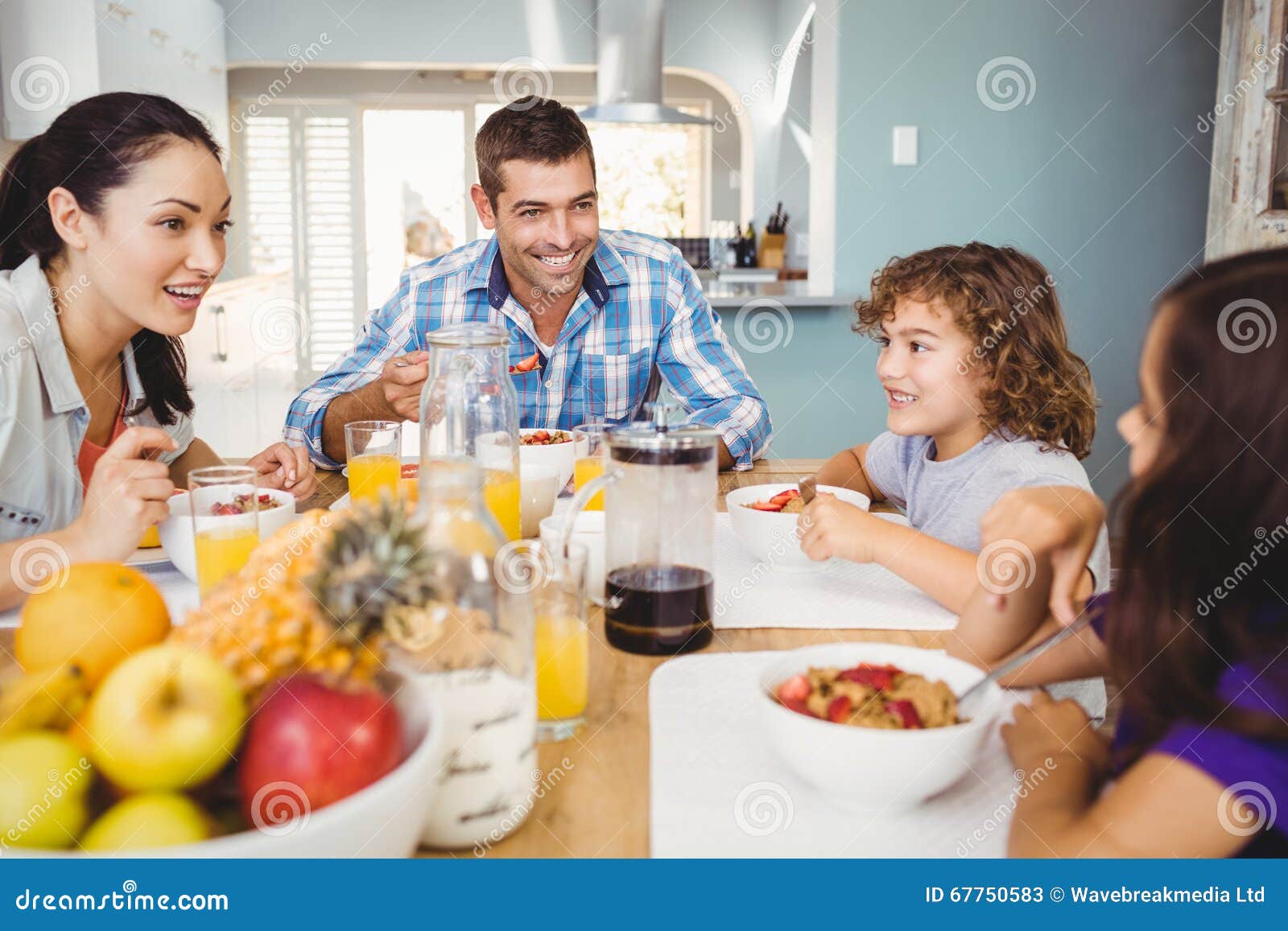Cheerful Family Eating Breakfast at Table Stock Image - Image of ...