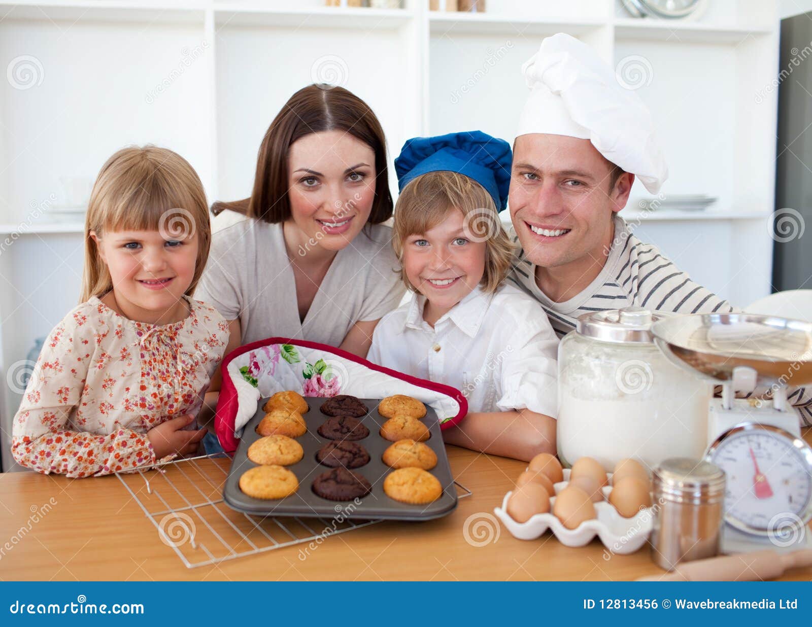 Cheerful Family Presenting Their Muffins Stock Photo - Image of family ...