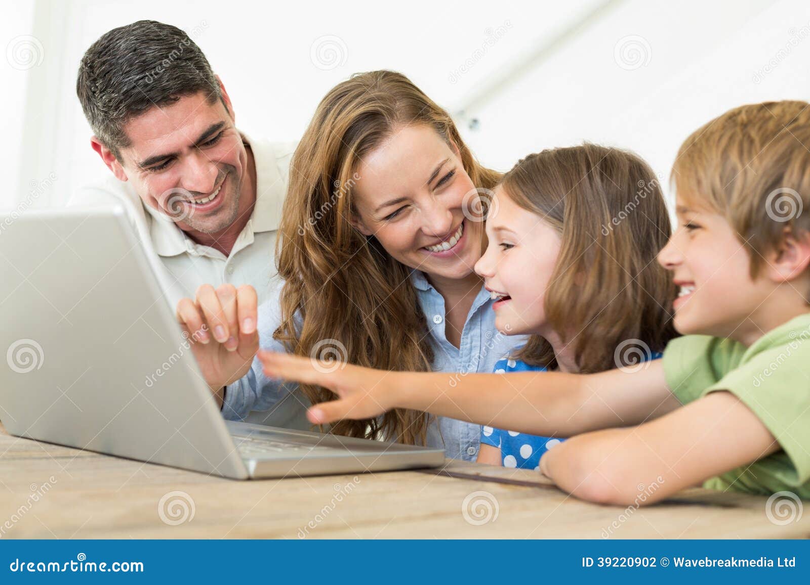Cheerful Family Using Laptop Stock Photo - Image of shoulders, indoors ...