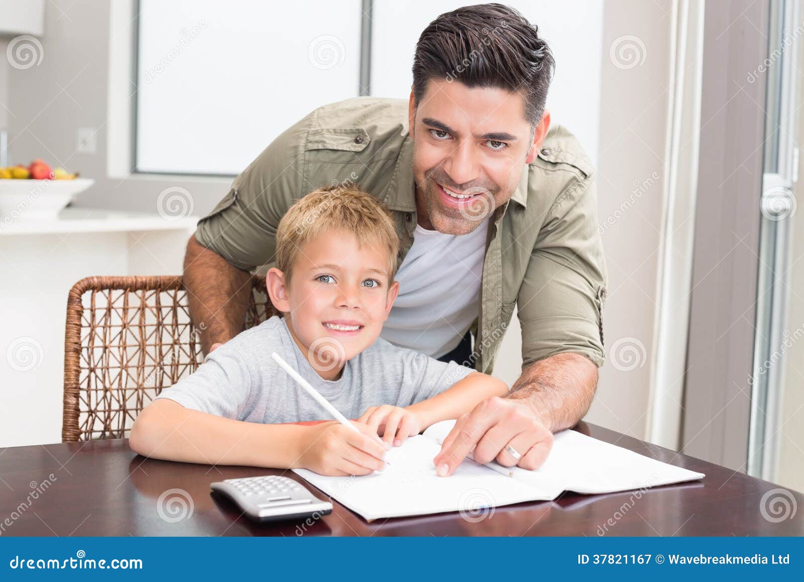 Cheerful Father Helping Son with Math Homework at Table Stock Image ...