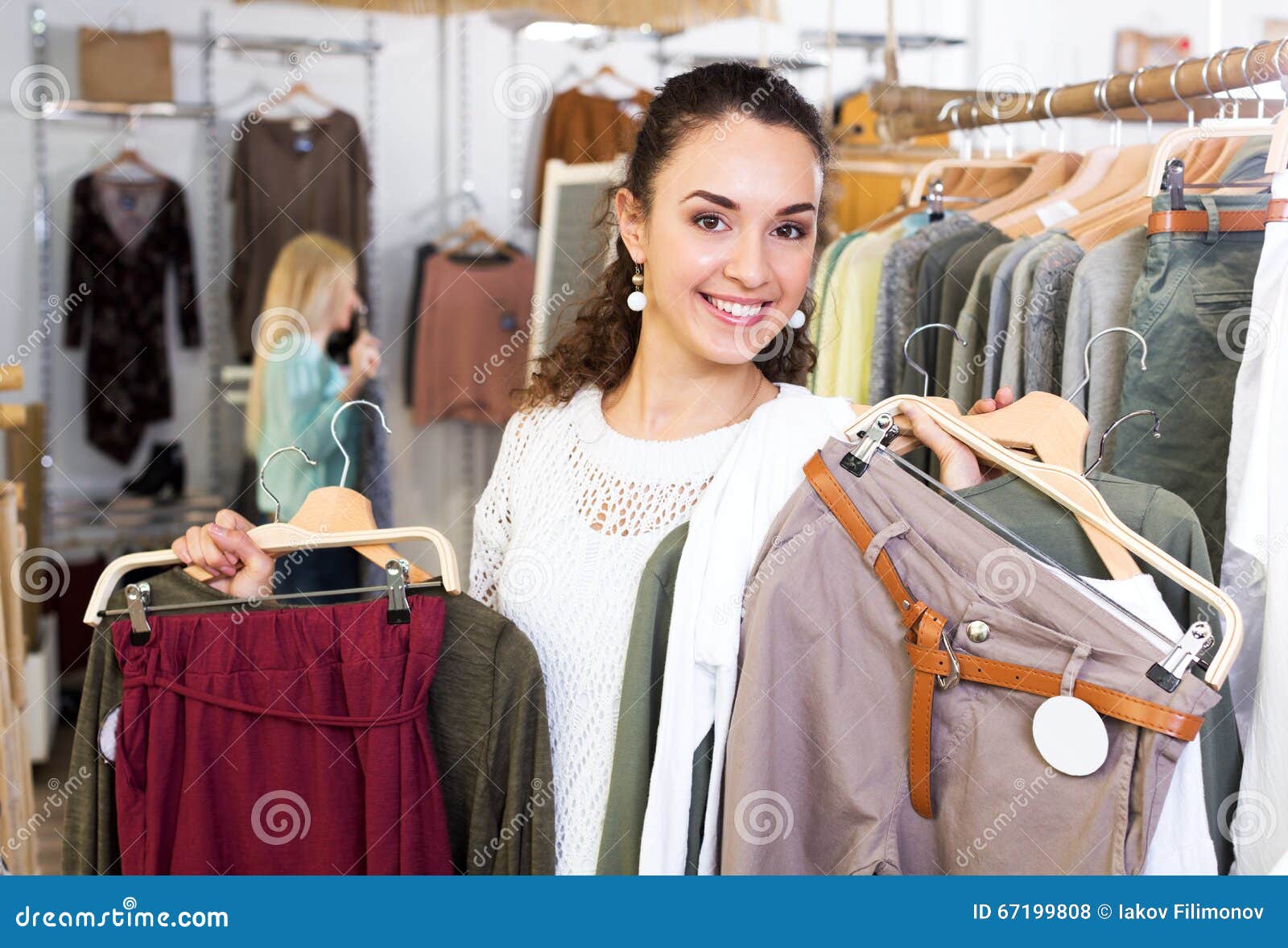 Cheerful Female Customer Selecting New Garments Stock Photo - Image of ...