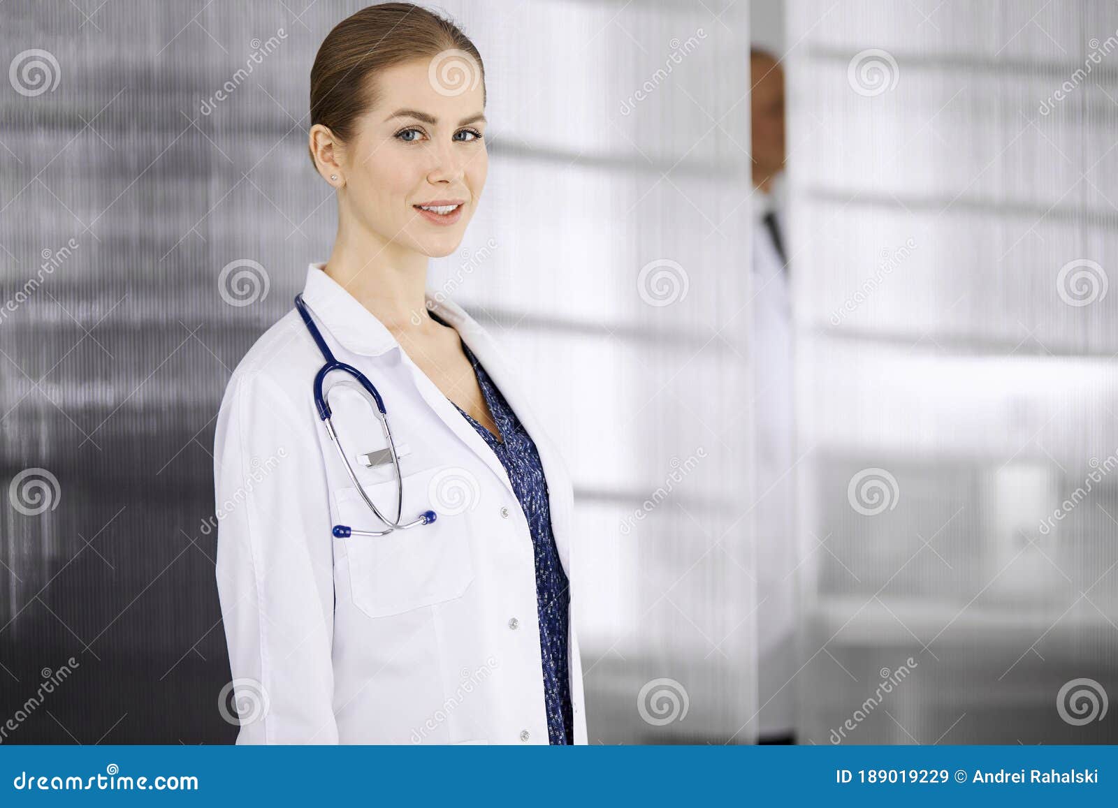 Cheerful Female Doctor Standing In Clinic Portrait Of Friendly Smiling