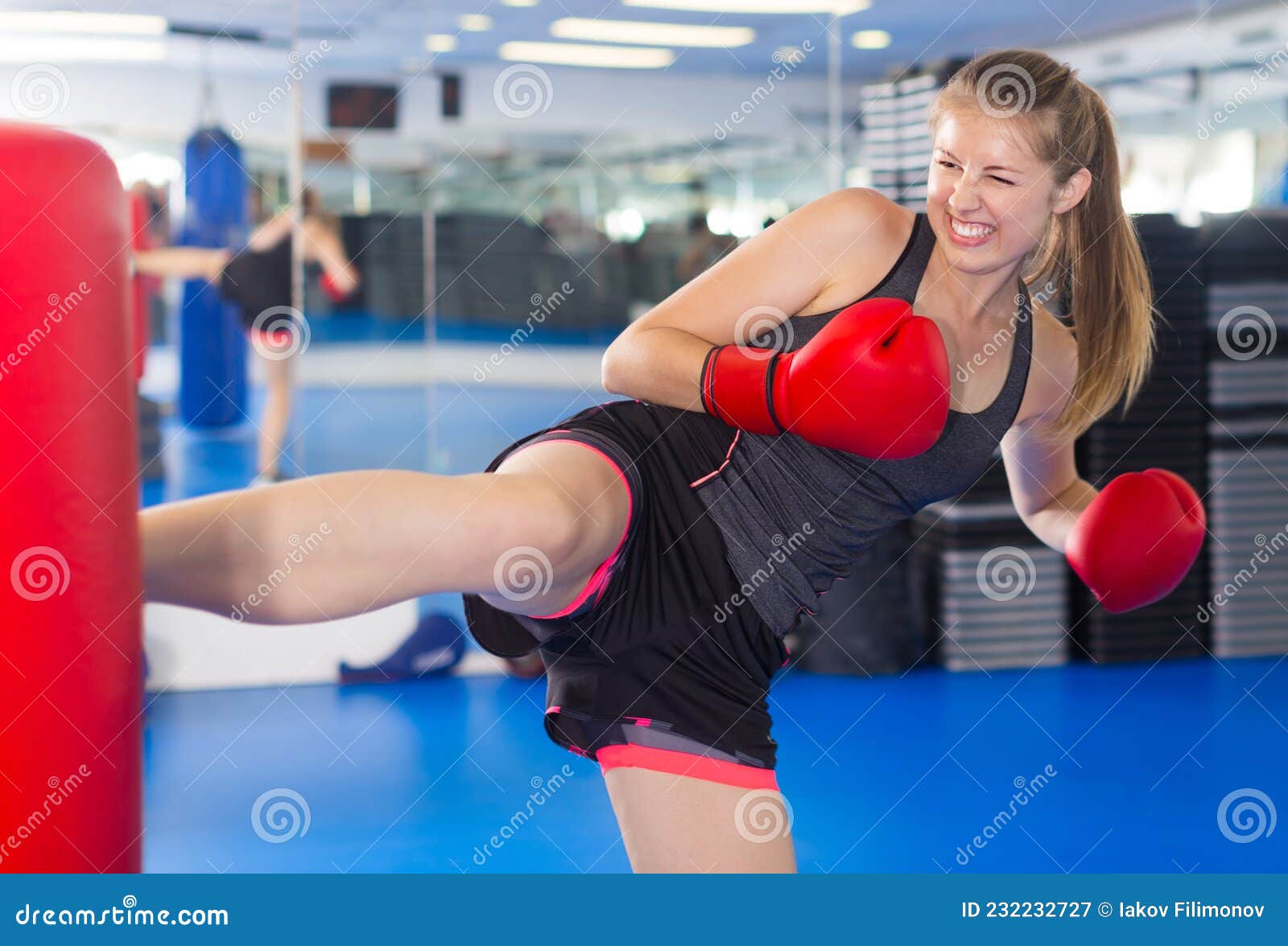 Cheerful Female is Doing Foot-kick Stock Image - Image of protection ...