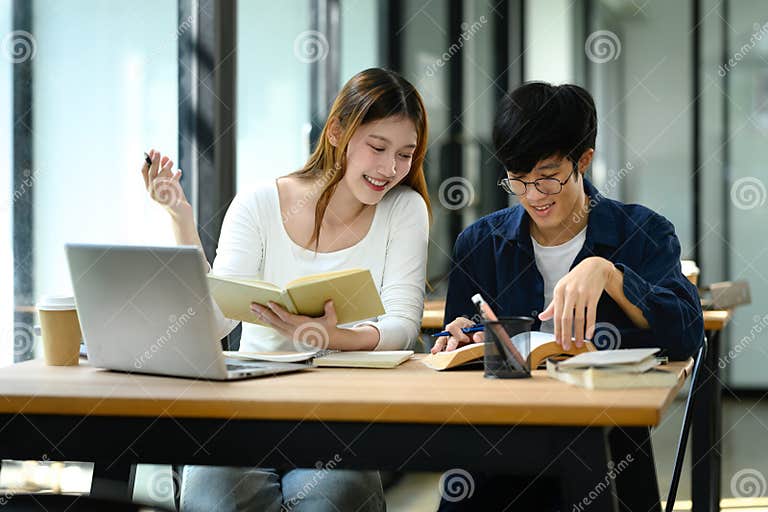 Cheerful Female Student Explains Her Notes while Working with Classmate ...