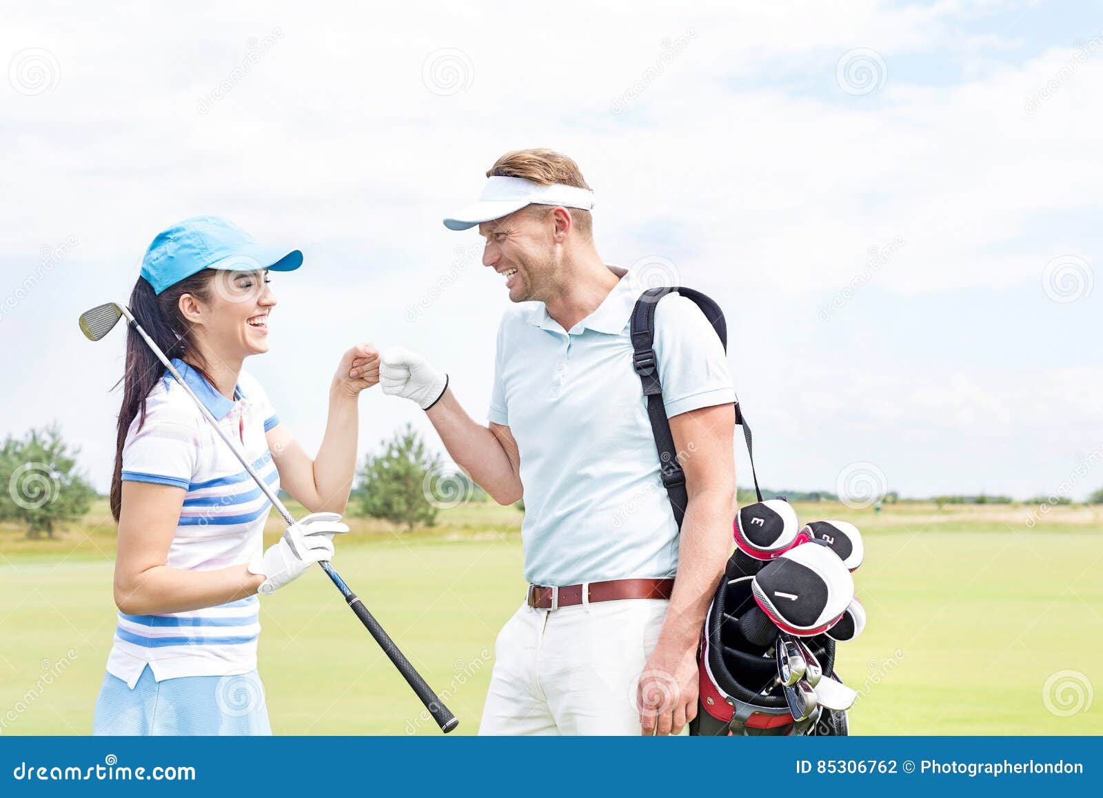 Cheerful Friends Giving High-five at Golf Course Stock Photo - Image of ...