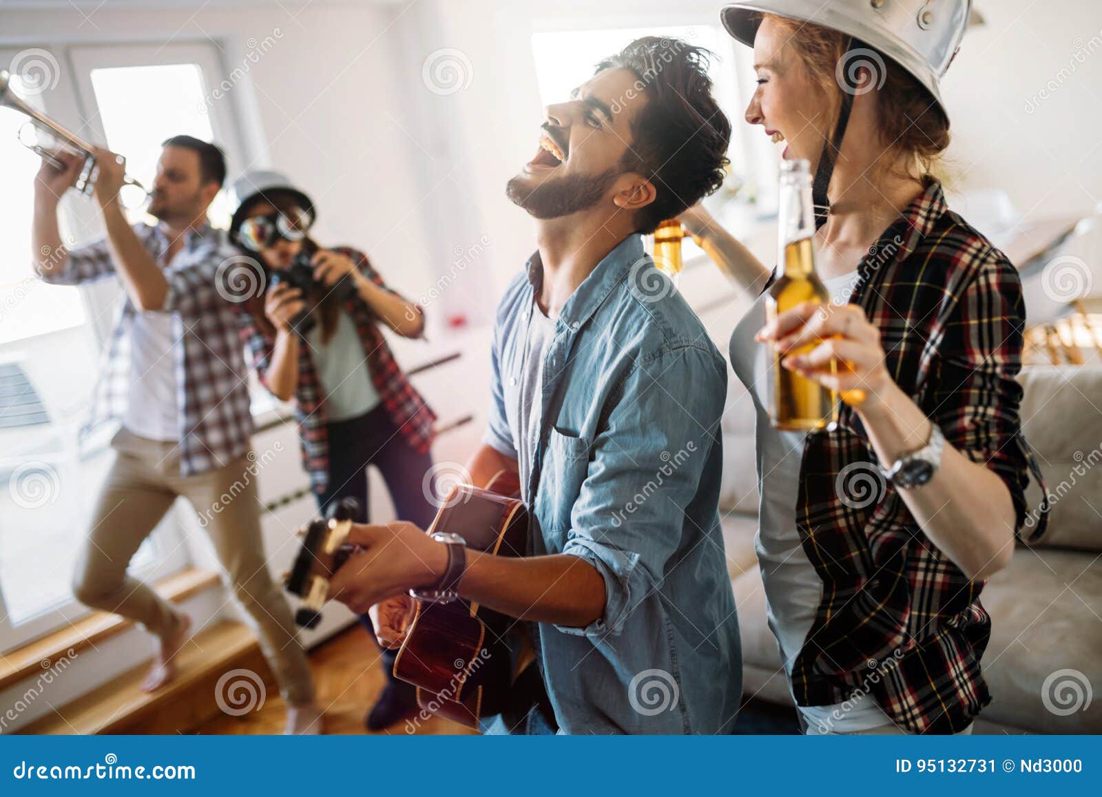 Cheerful Friends Having Party Together and Playing Instruments Stock ...