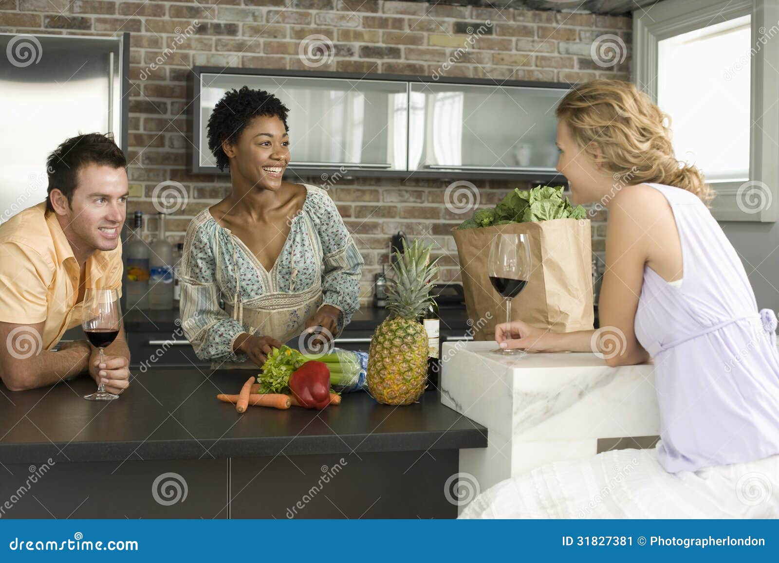 Cheerful Friends at Kitchen Counter Stock Image - Image of drink ...