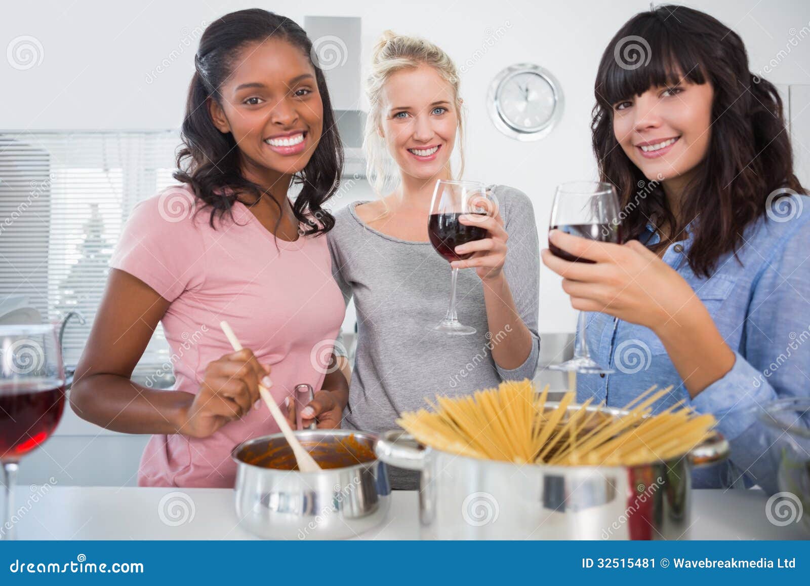 Cheerful Friends Making Spaghetti Dinner Together and Drinking R Stock ...