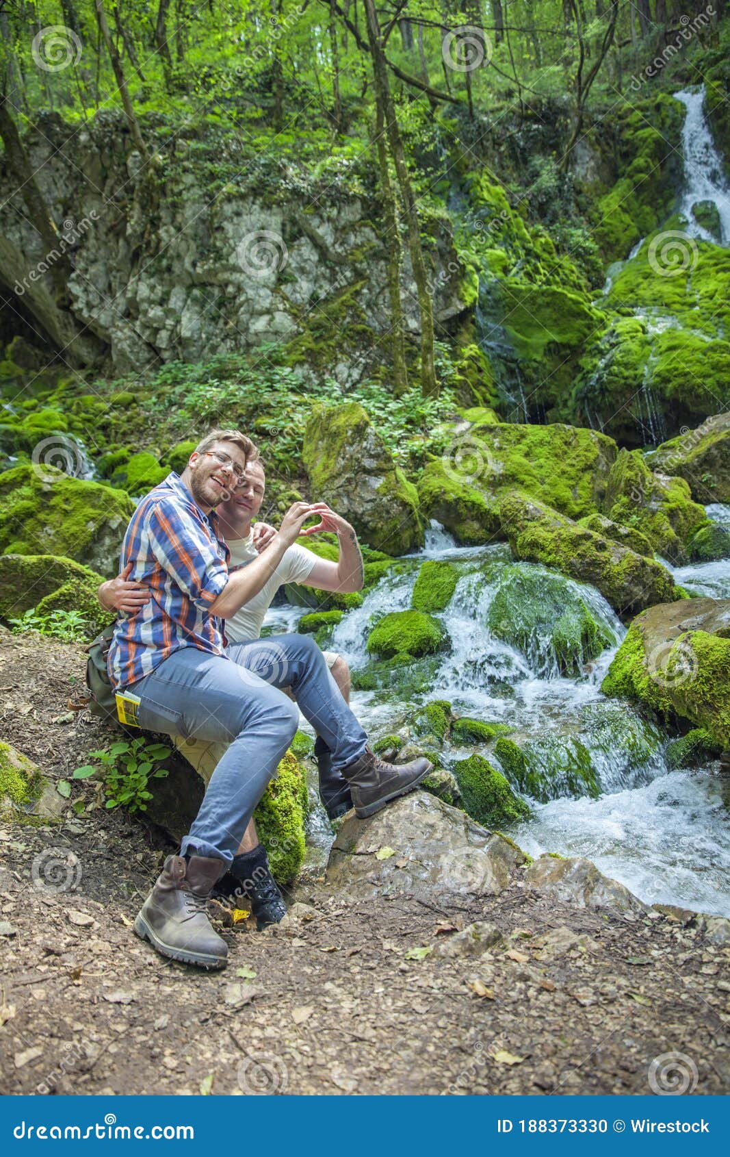 Cheerful Friends Posing in Nature by a Waterfall Stock Photo - Image of ...