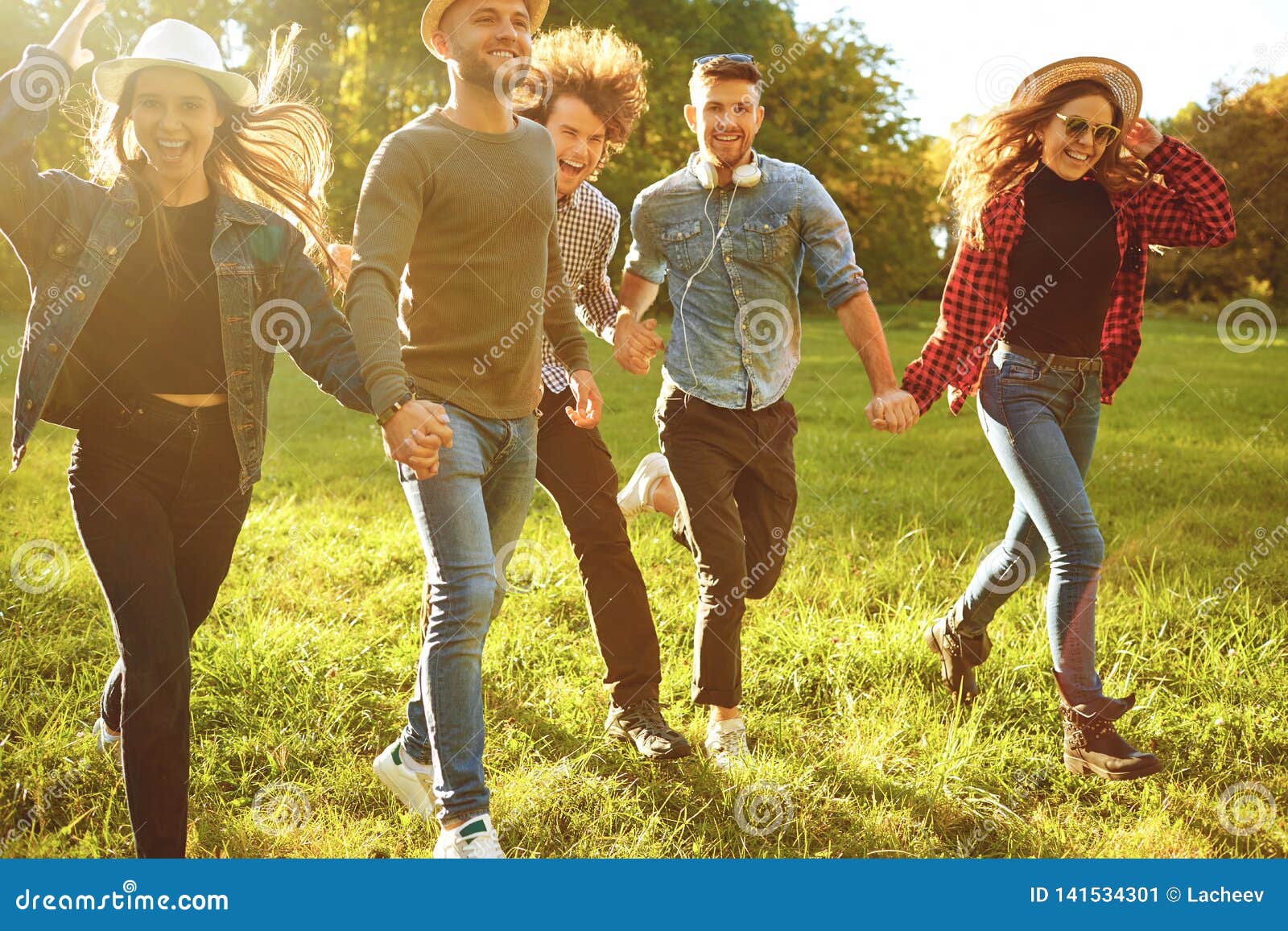 Cheerful Friends are Running in the Park. Stock Image - Image of ...