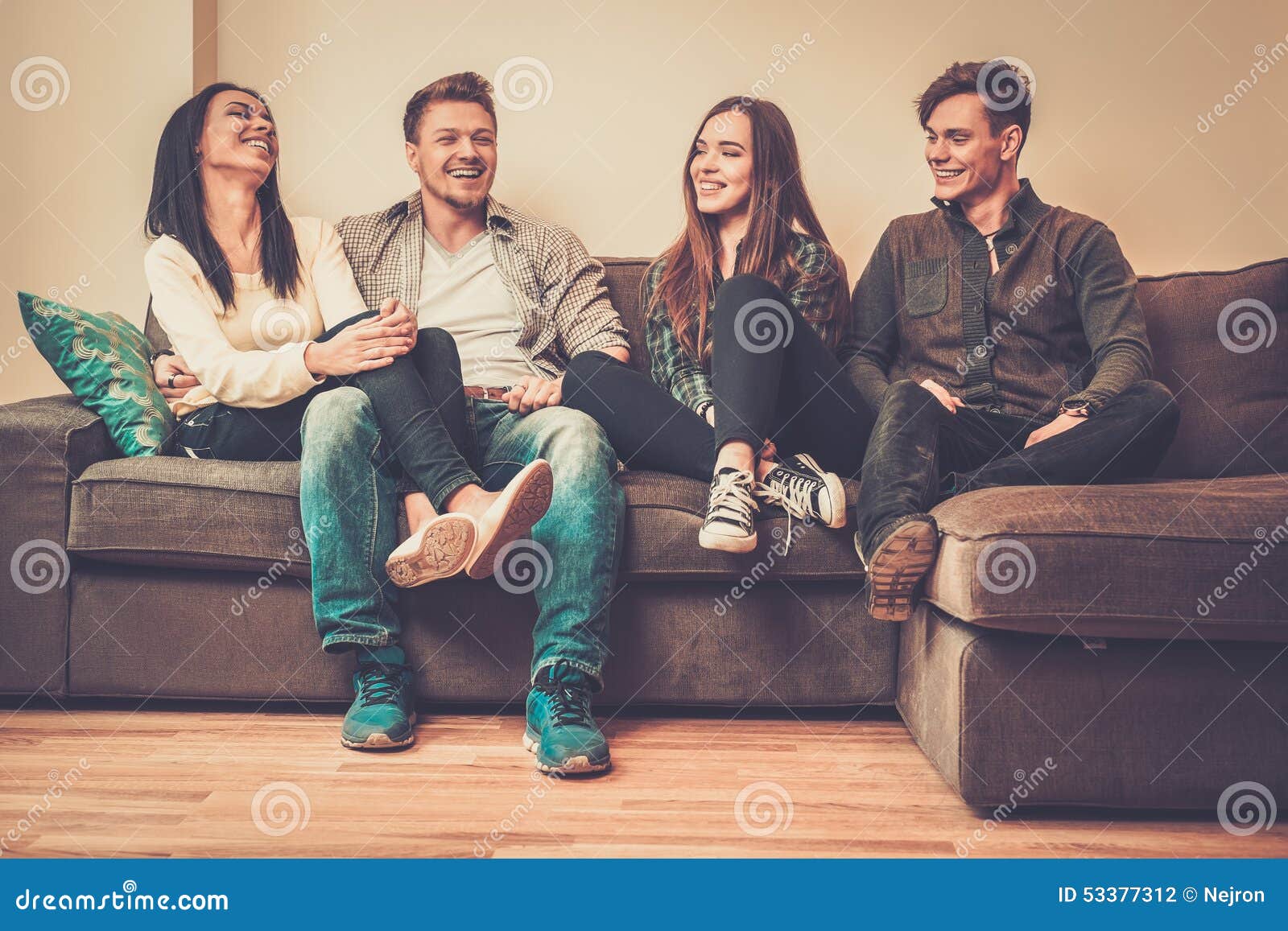 Cheerful friends on a sofa stock photo. Image of relaxing - 53377312