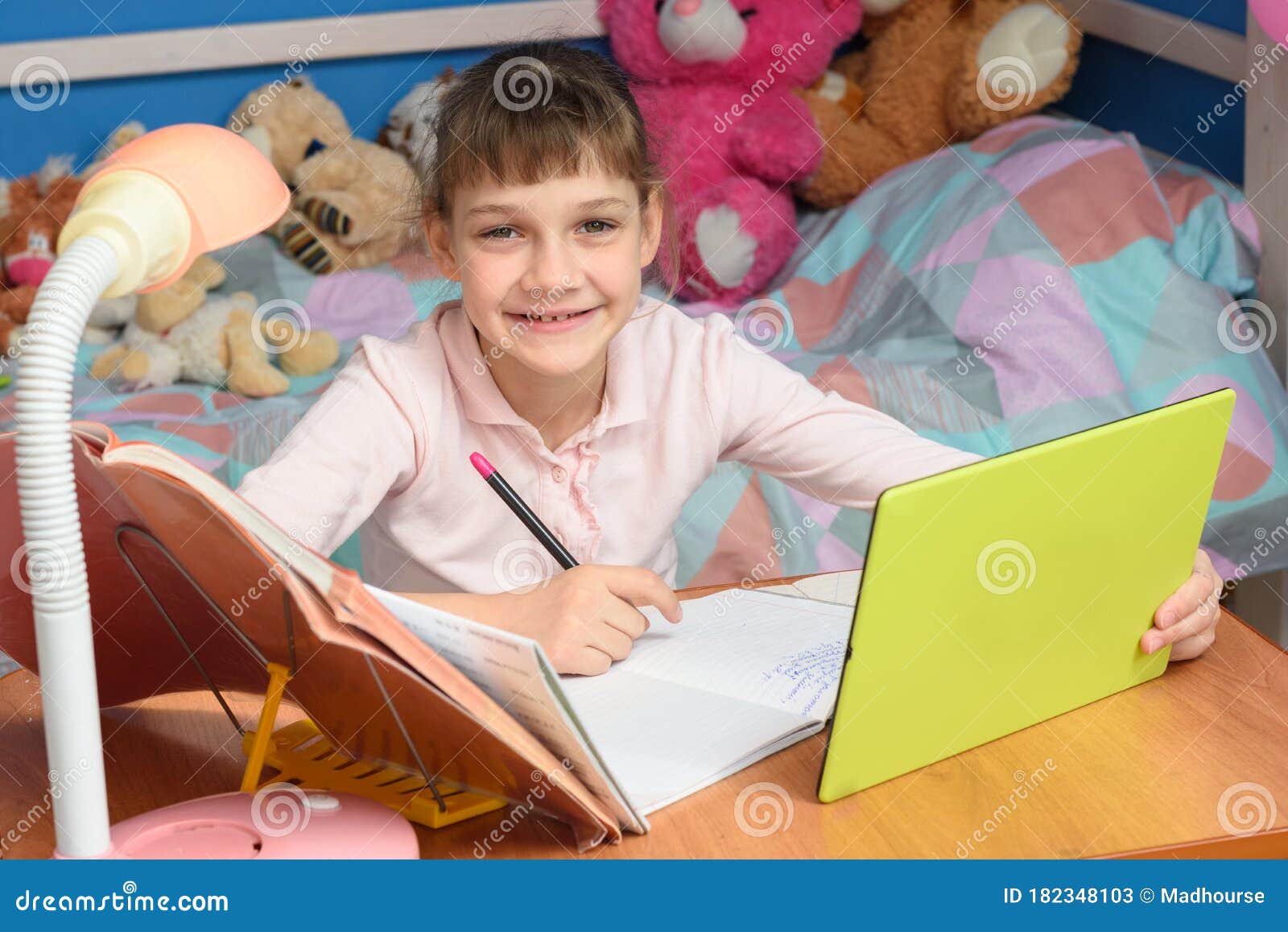 Cheerful Girl Doing Homework Using Tablet Computer Stock Image - Image ...