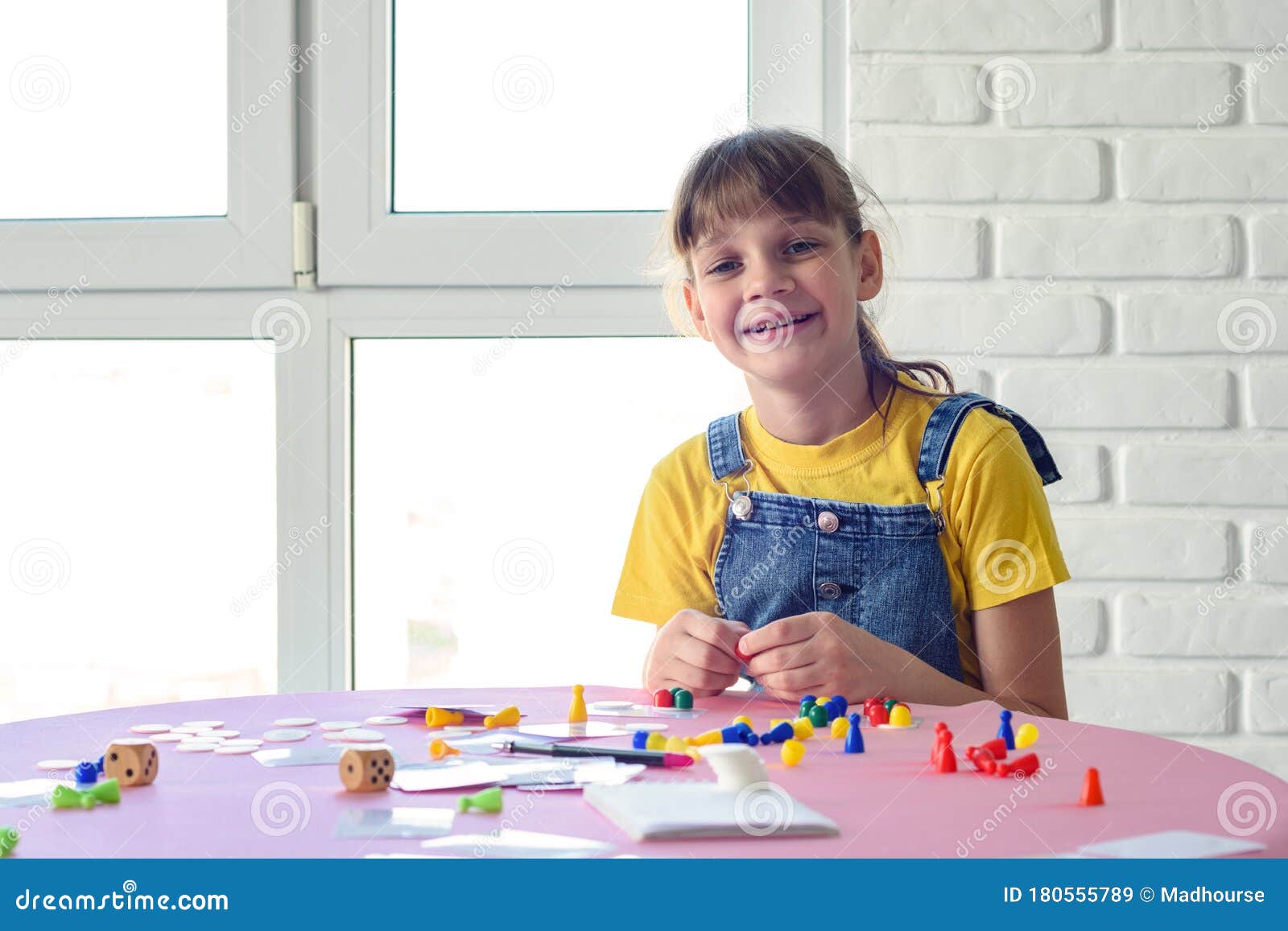 Cheerful Girl Plays Board Games at the Table and Looked into the Frame ...