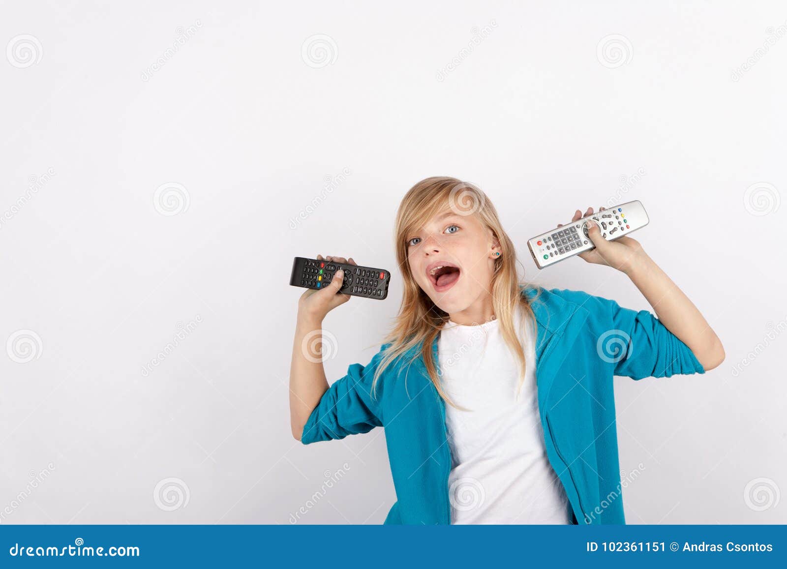 Cheerful Girl Showing Remote Controls Stock Image - Image of female ...