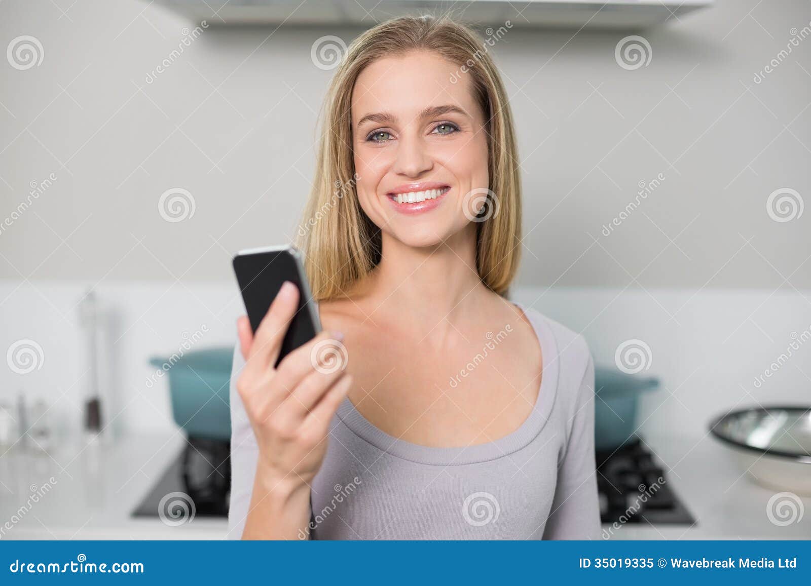Cheerful Gorgeous Model Holding Smartphone Looking at Camera Stock ...