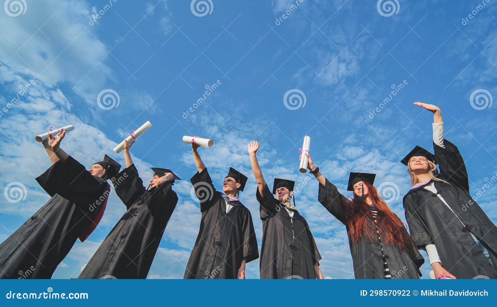 Cheerful Graduates Pose with Raised Diplomas on a Sunny Day. Stock ...