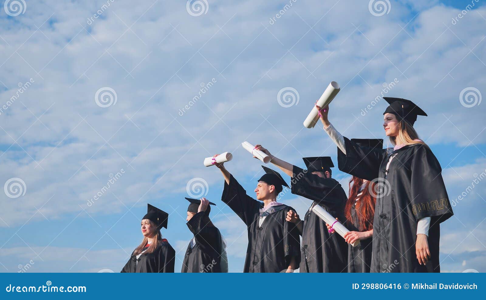 Cheerful Graduates Pose with Raised Diplomas on a Sunny Day. Stock ...