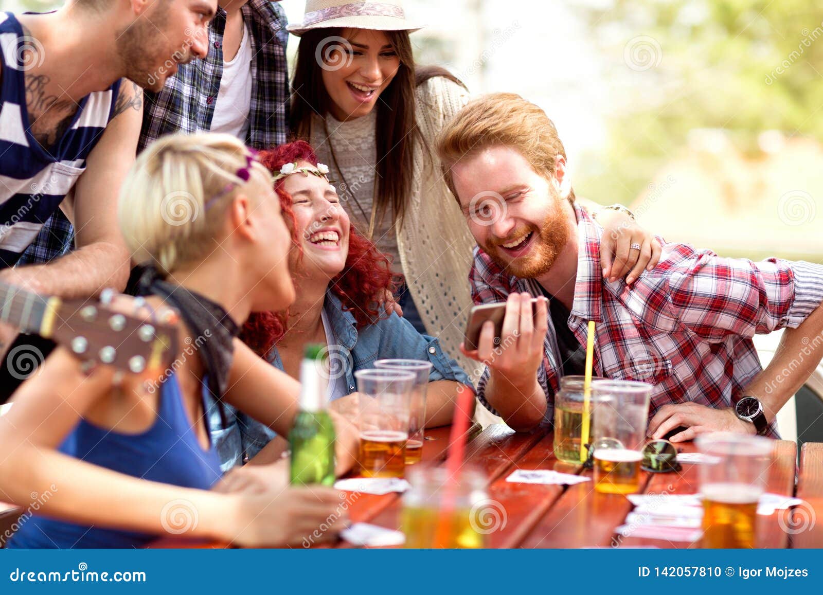Cheerful Group Laughing at Something Interesting on Mobile Phone Stock ...